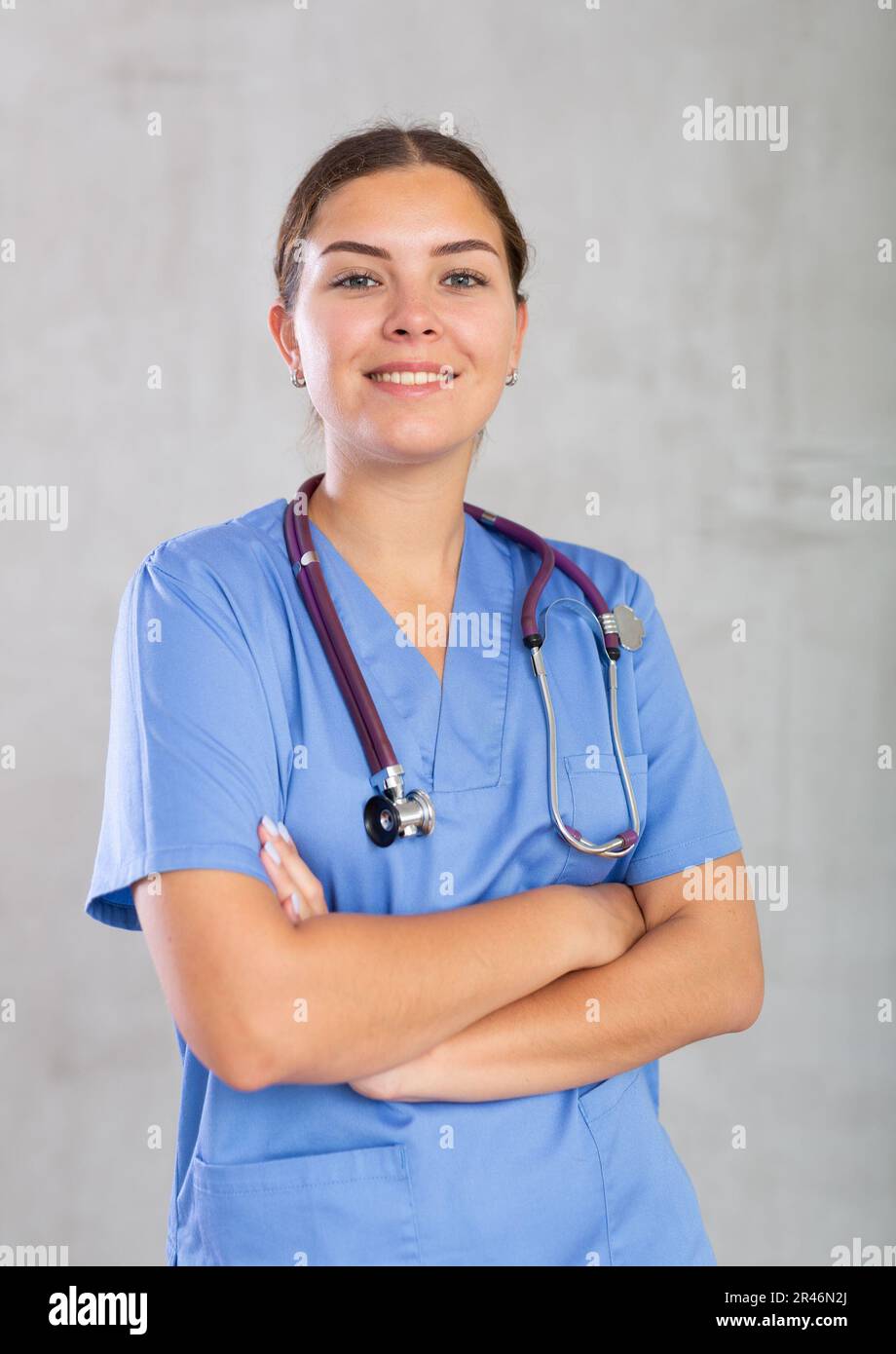 Young happy female nurse standing smiling with pride Stock Photo - Alamy