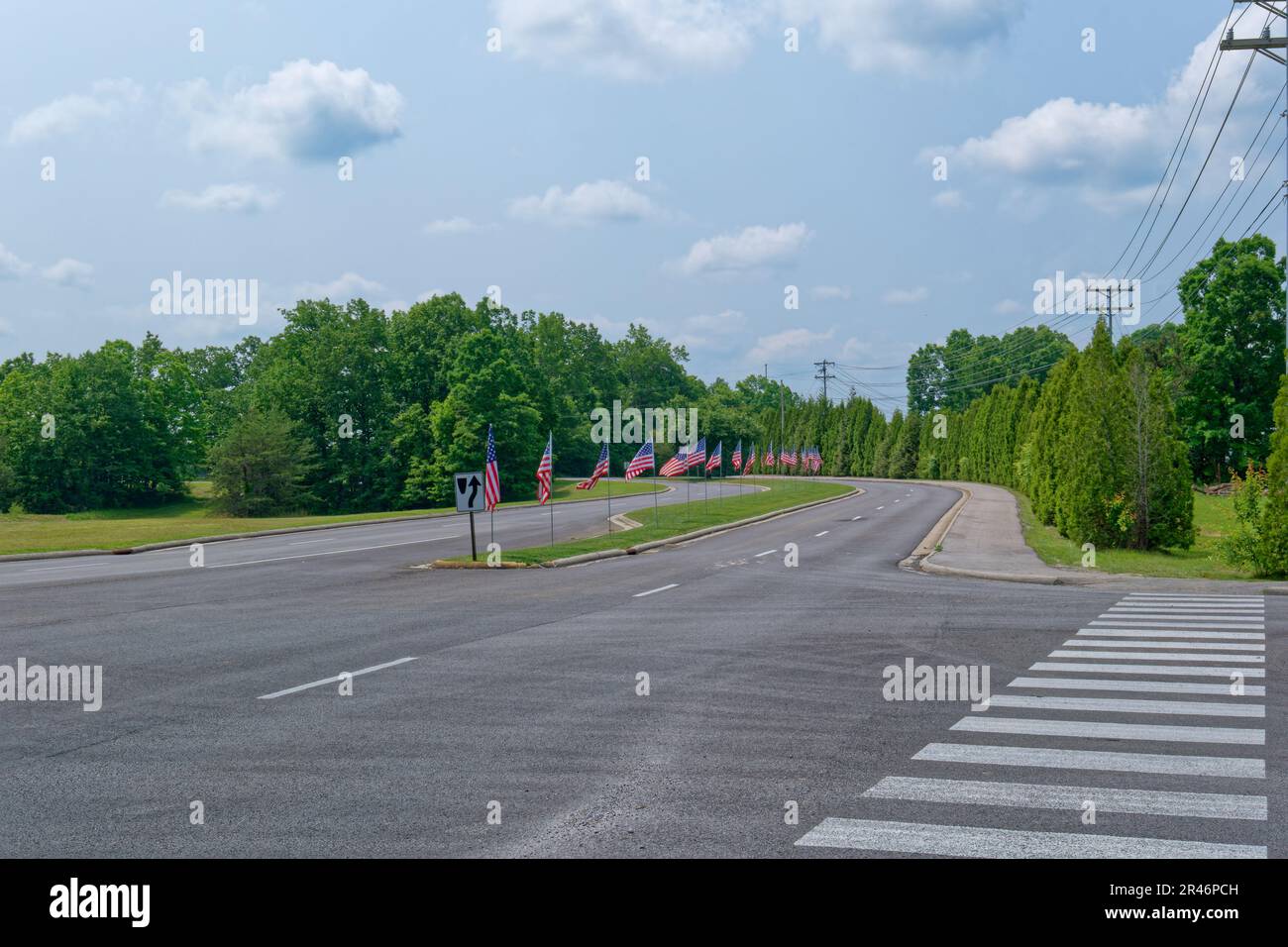 Several full size American flags lined up down the middle of the ...