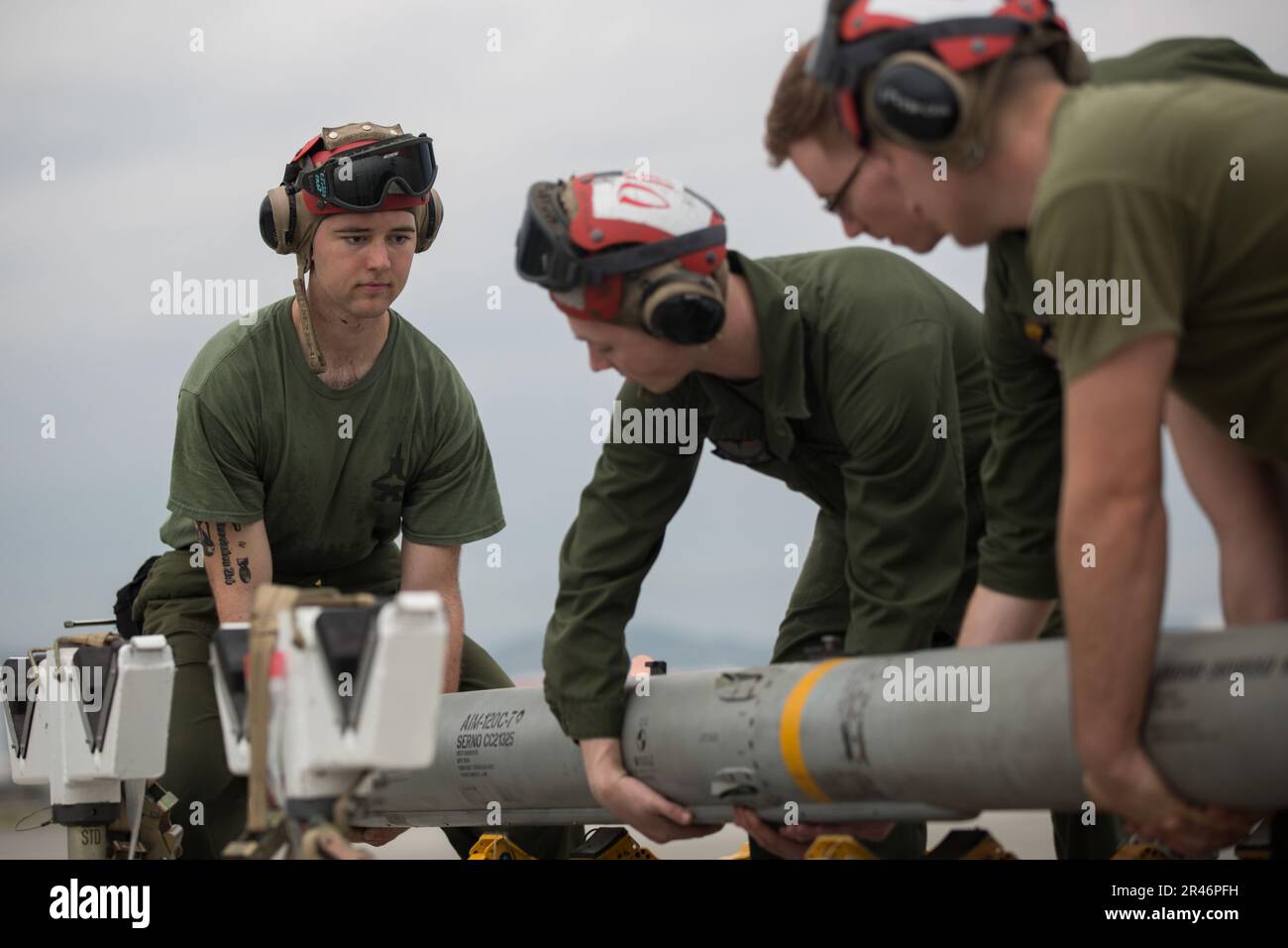 U.S. Marines with Marine Fighter Attack Squadron 242 prepare to load an ...