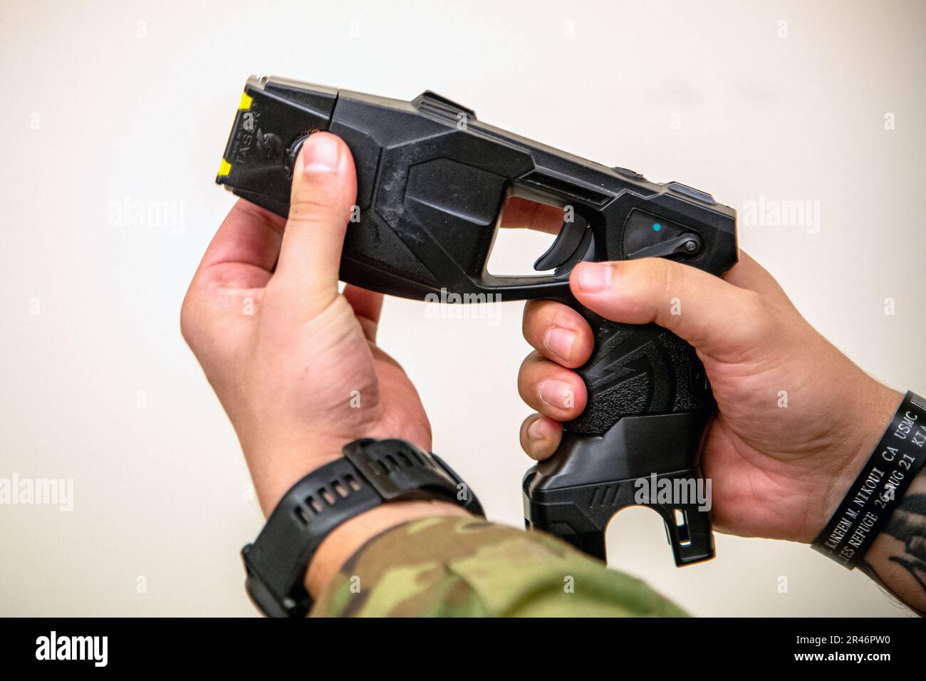 An Airman from the 423d Security Forces Squadron arms a Taser during a ...