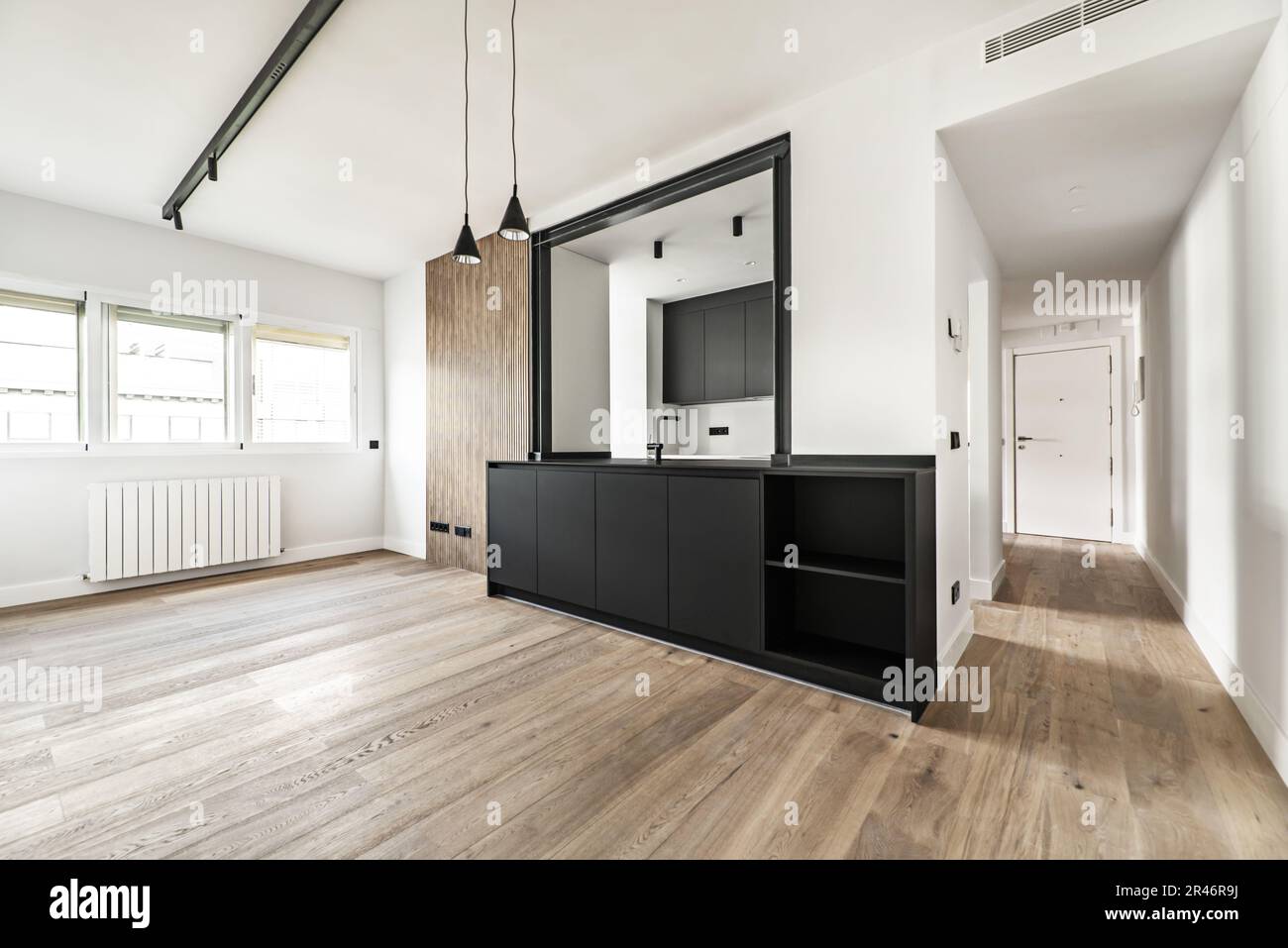 Living room of a recently renovated empty house with a black sideboard ...