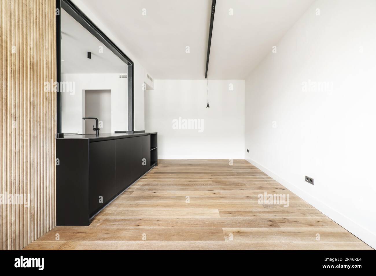 Living room of a recently renovated empty house with a black cabinet ...