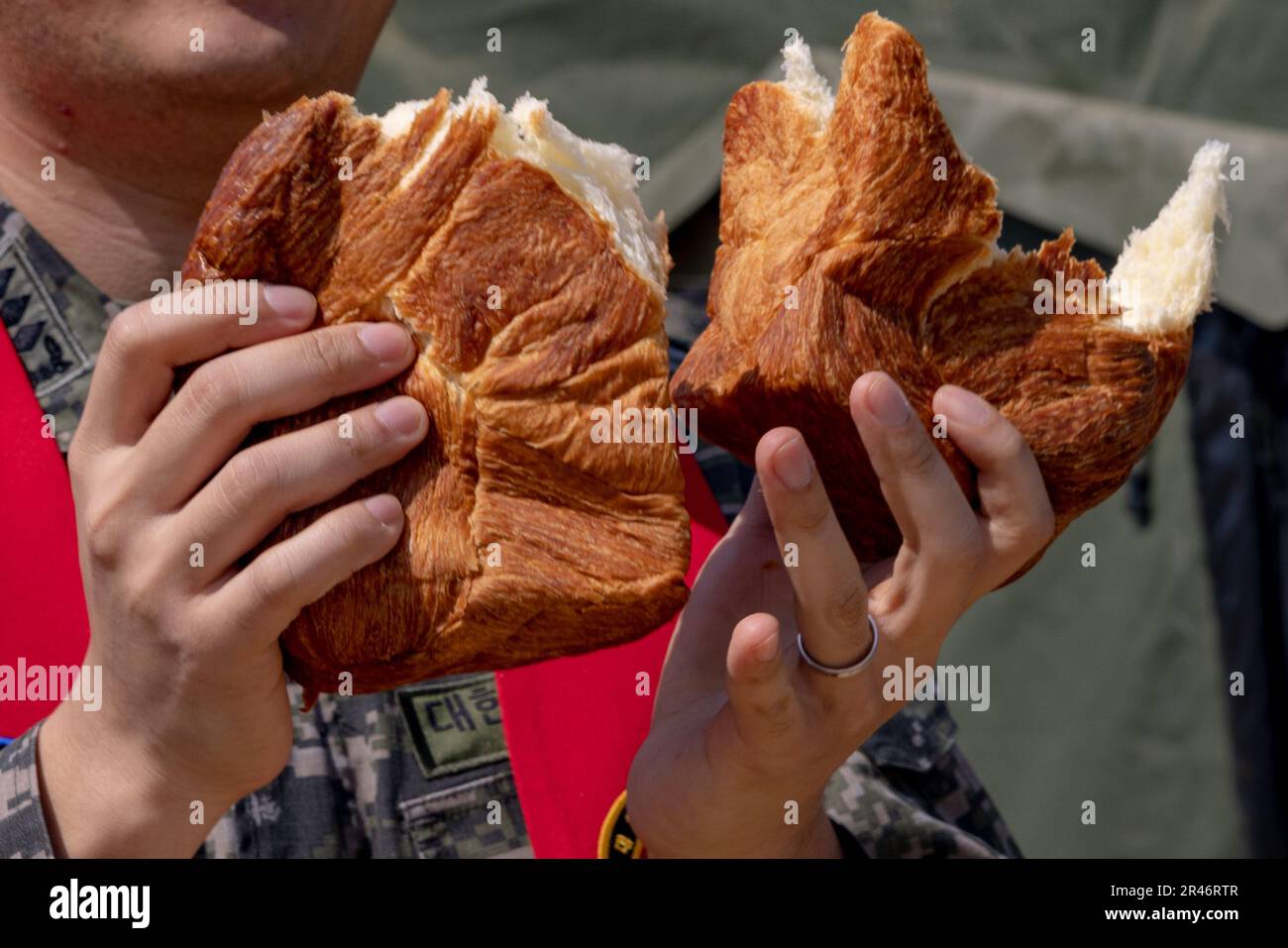 Republic of Korea Navy Capt. Kim Dong Woo, breaks ceremonial bread for ...