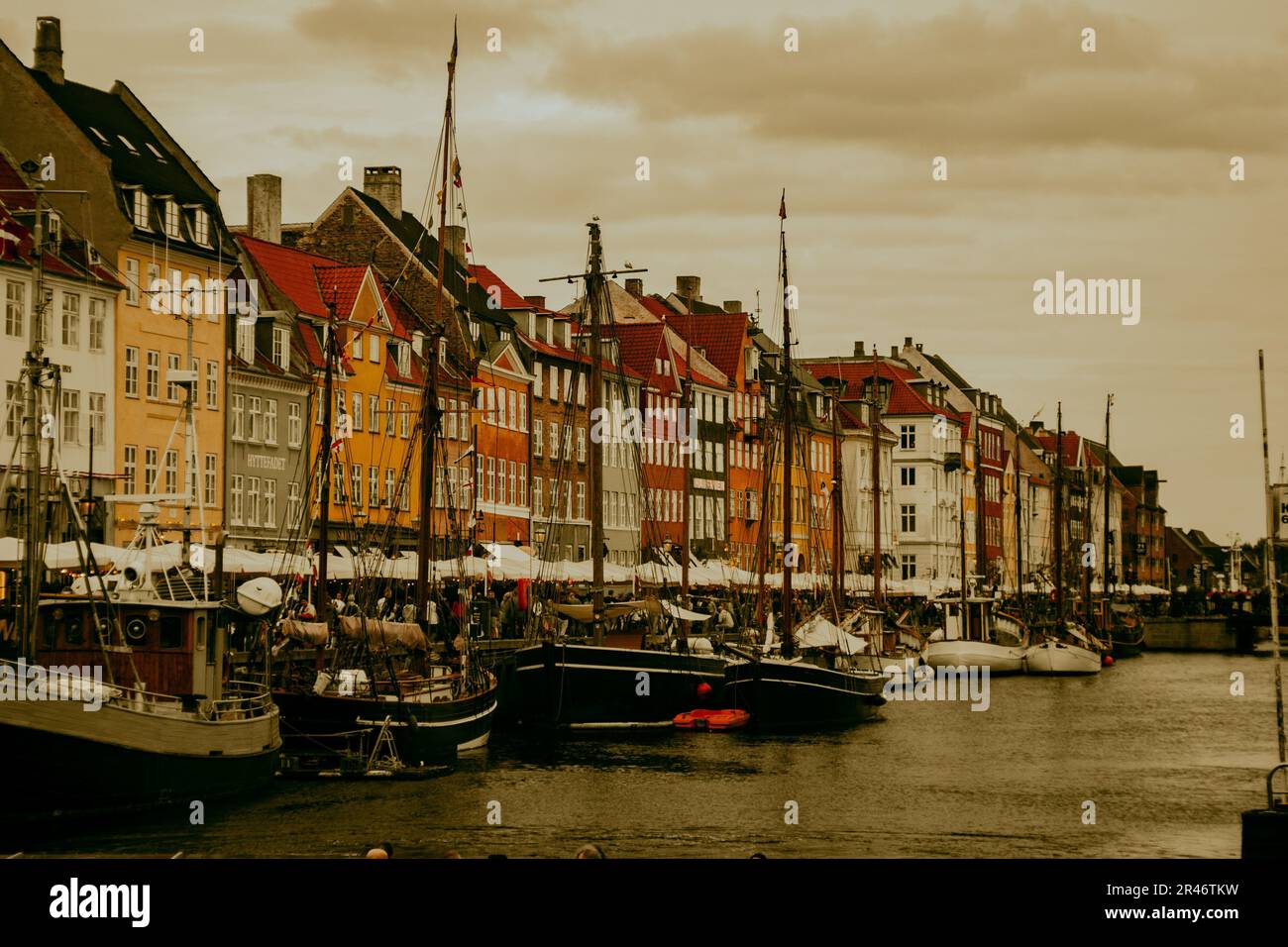 A bustling harbor, featuring several boats docked near coastal ...