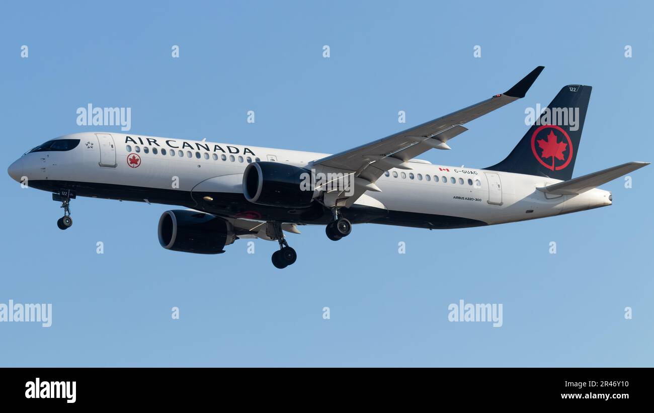 An Air Canada aircraft soaring against a blue sky backdrop Stock Photo ...