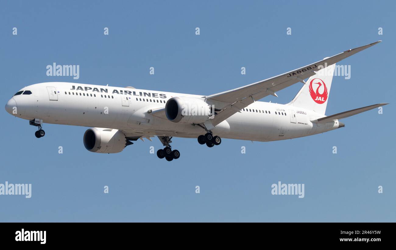 A Japan Airlines aircraft soaring against a blue sky backdrop Stock ...