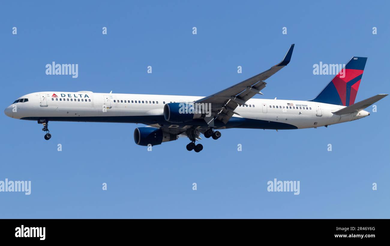 A Delta Airlines aircraft soaring against a blue sky backdrop Stock ...