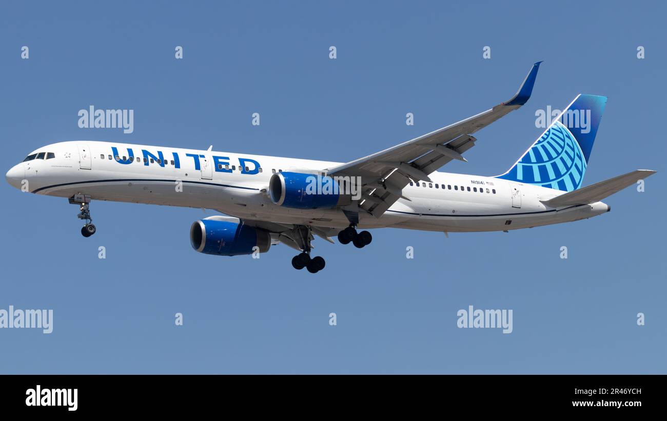 A United Airlines aircraft soaring against a blue sky backdrop Stock ...