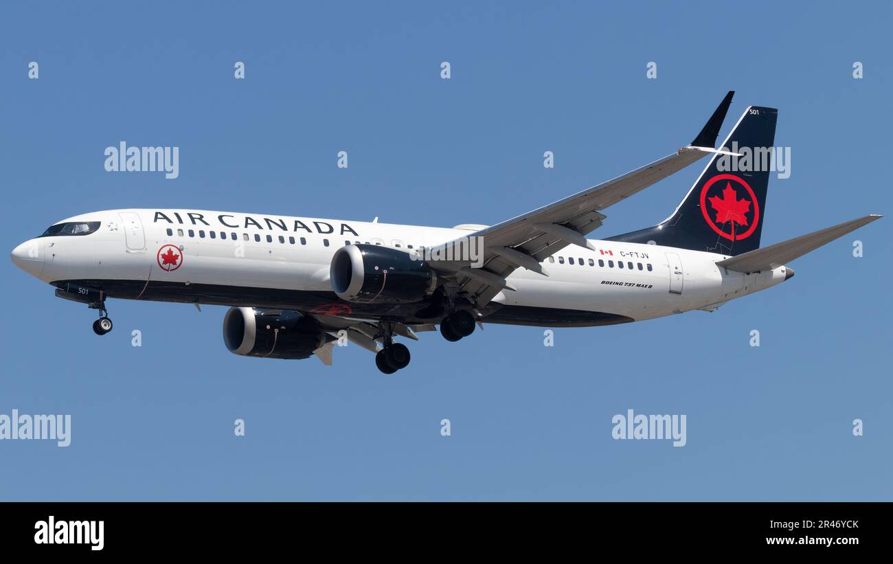 An Air Canada aircraft soaring against a blue sky backdrop Stock Photo ...