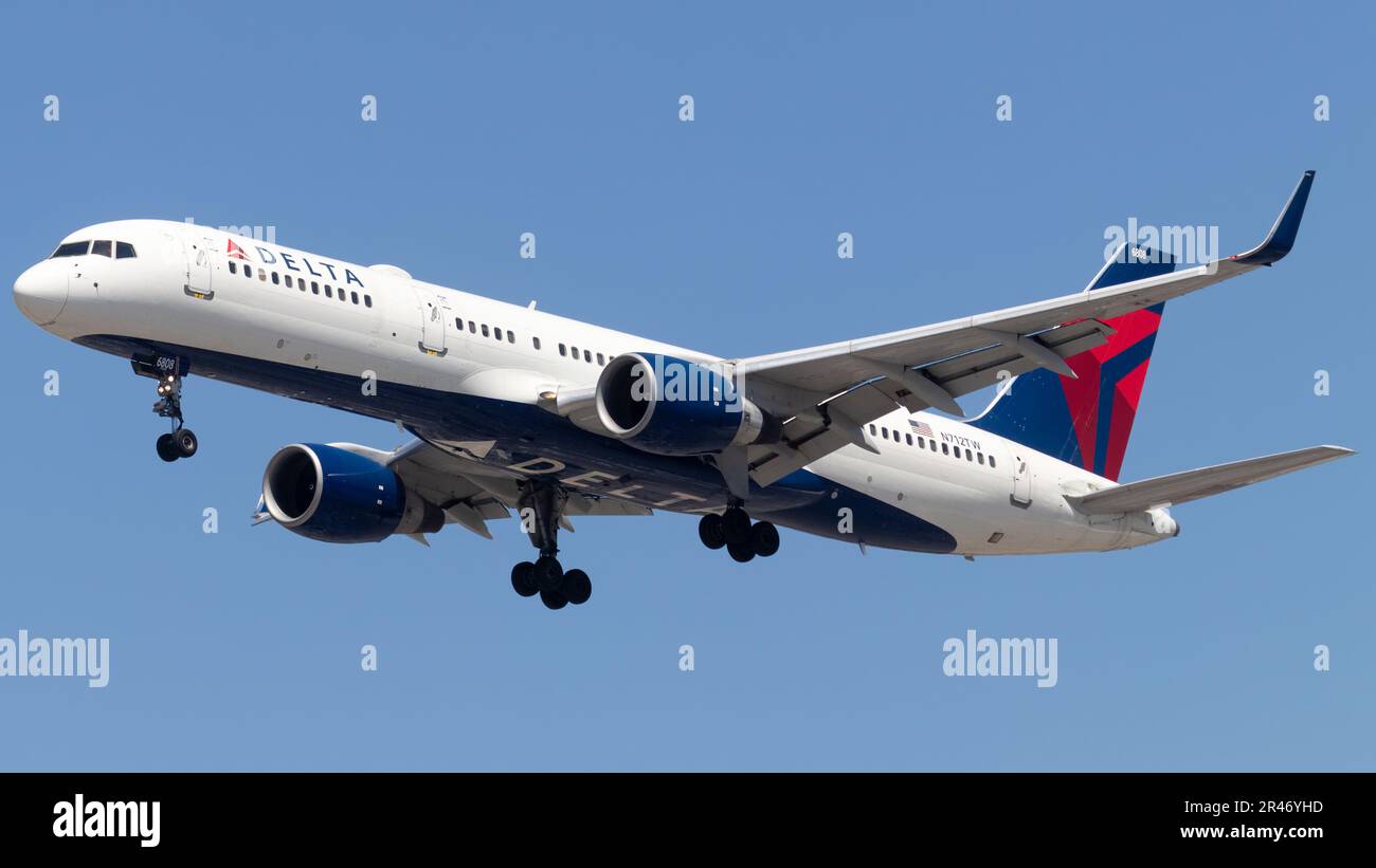 A Delta Airlines aircraft soaring against a blue sky backdrop Stock ...