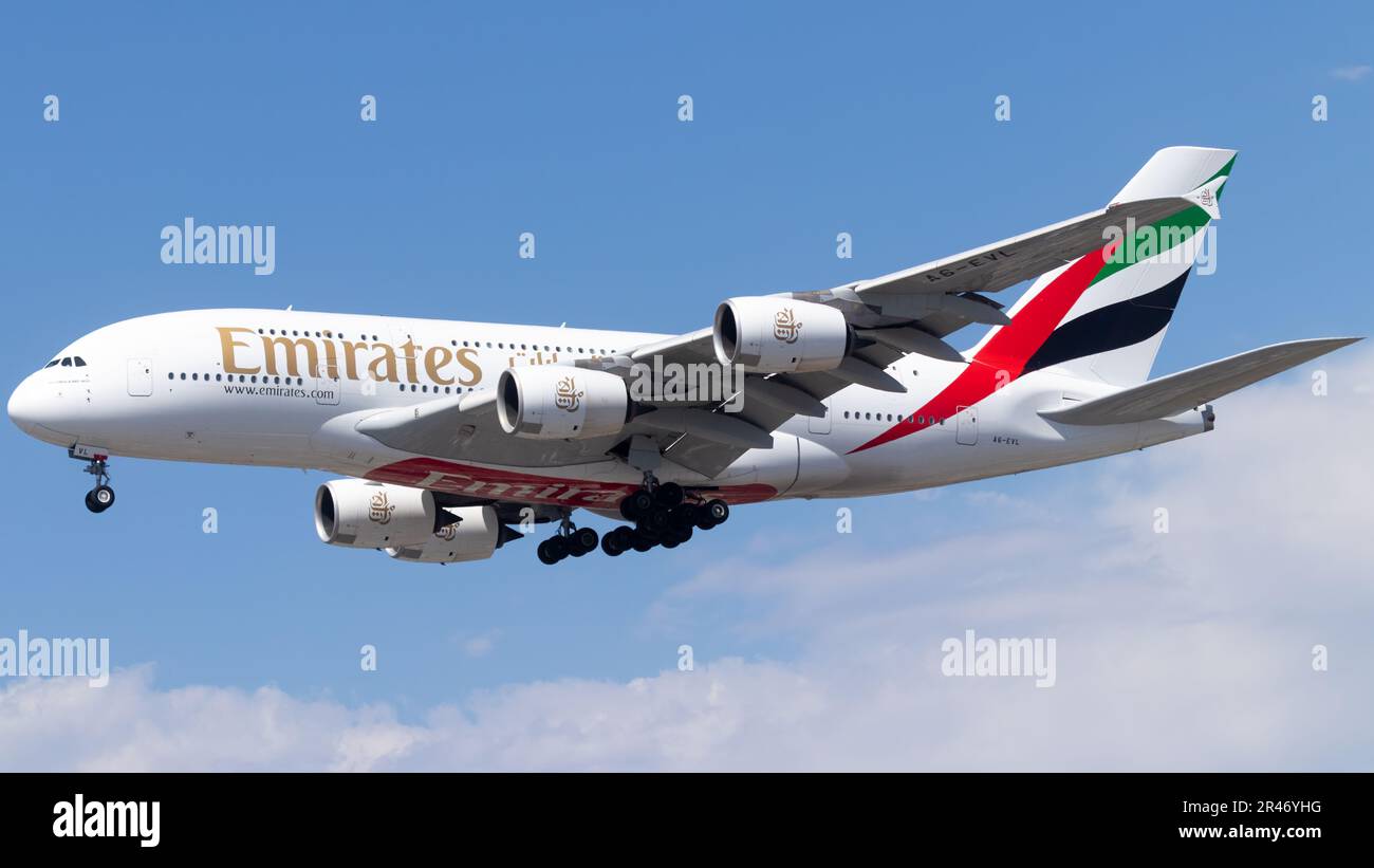 An Emirates Airlines aircraft soaring against a blue sky backdrop Stock ...