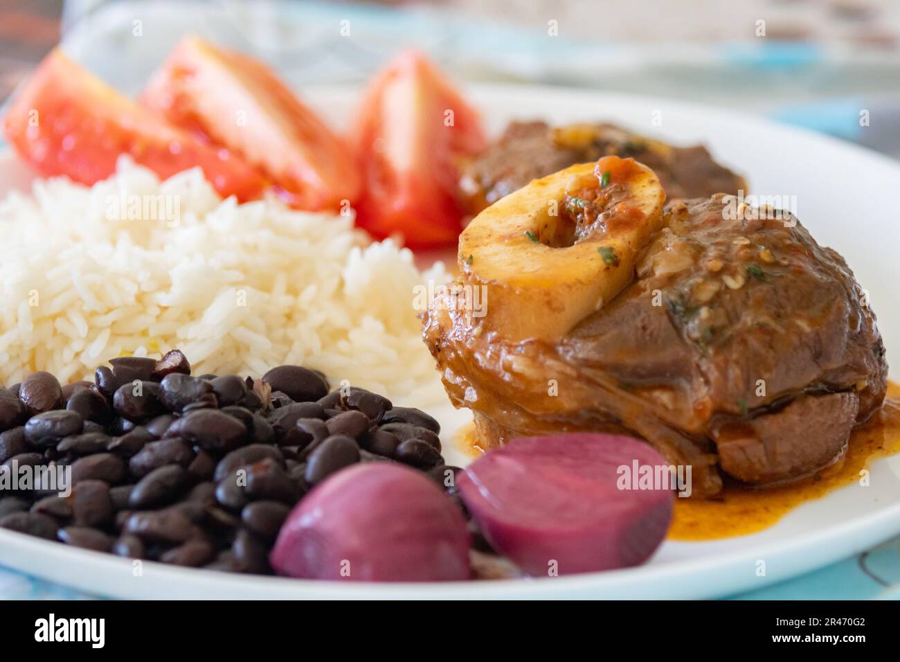 Traditional Brazilian daily meal, black beans, rice, meat, salad. real ...
