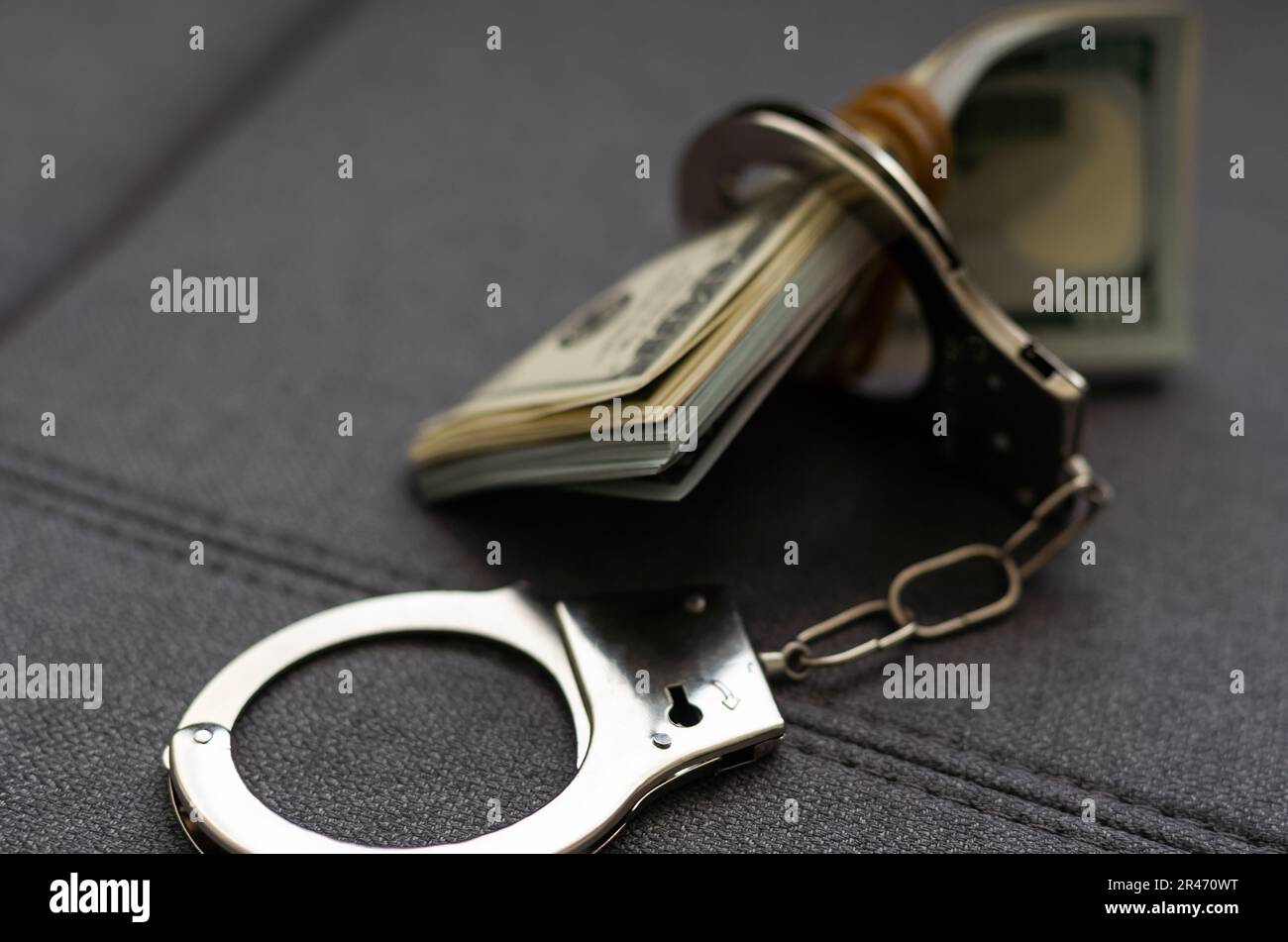 Banknotes dollars money and handcuffs isolated on black background ...