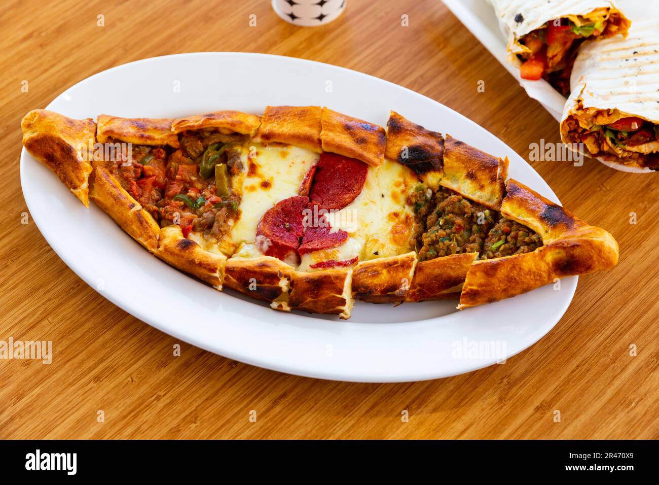 Pide, Turkish flat bread with mixed filling Stock Photo - Alamy