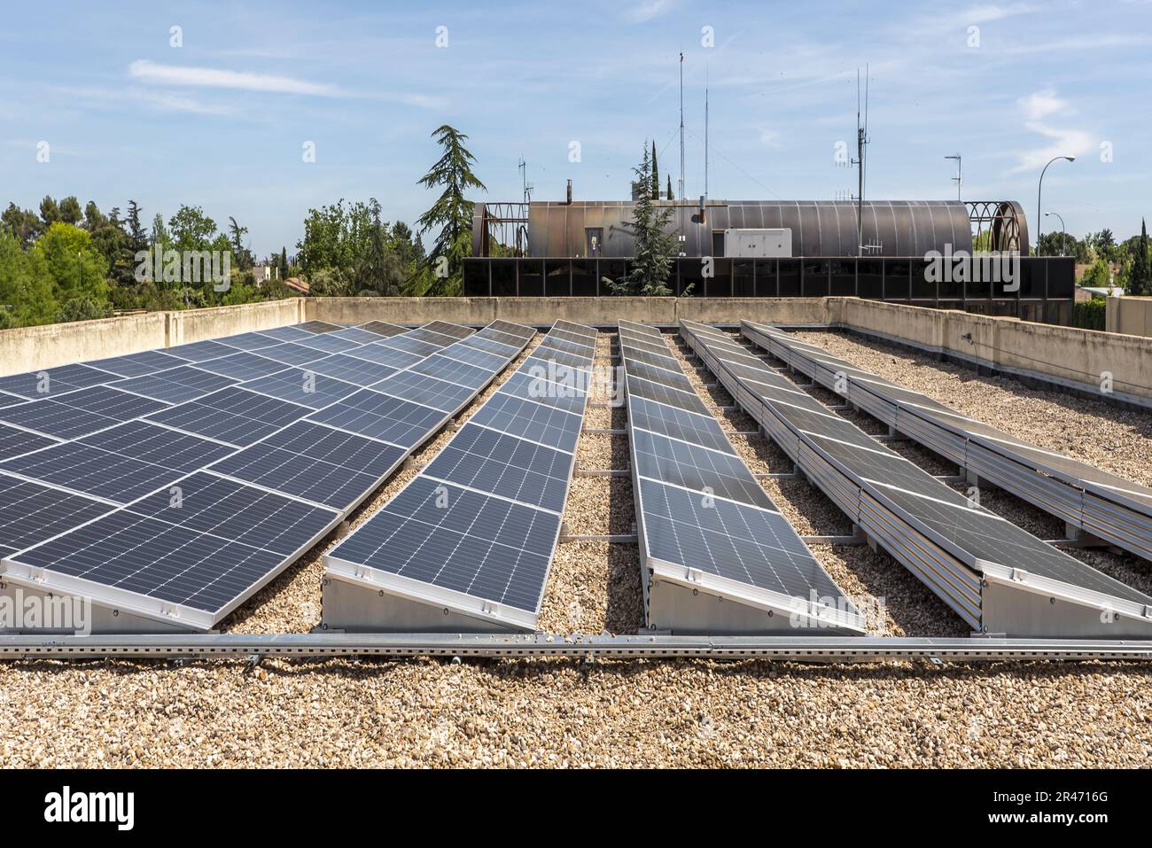 Rows of photovoltaic panels on the roof of an office building ...