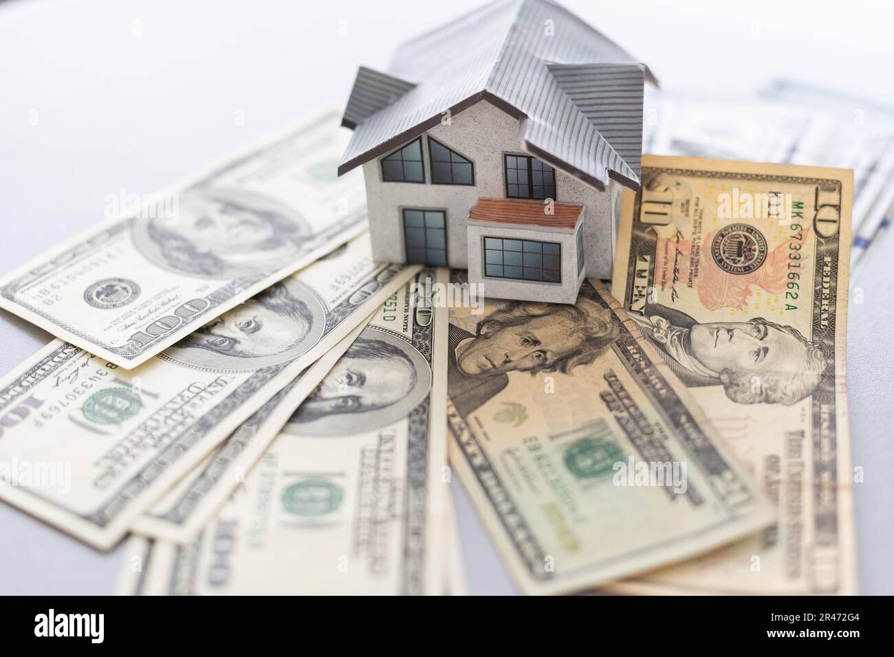 Investment, model house and money Stock Photo - Alamy