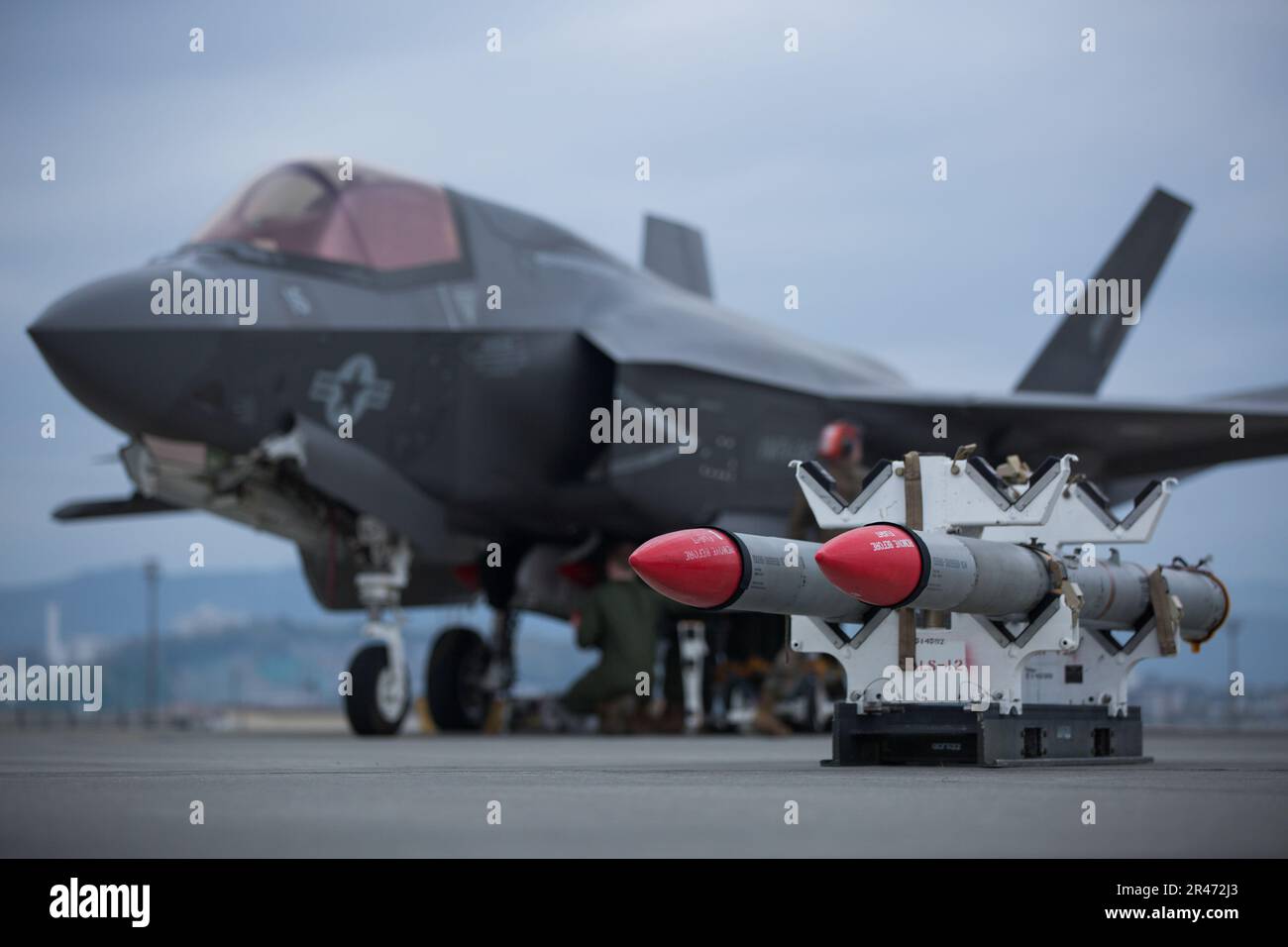 U.S. Marines with Marine Fighter Attack Squadron 242 load AIM-120 ...
