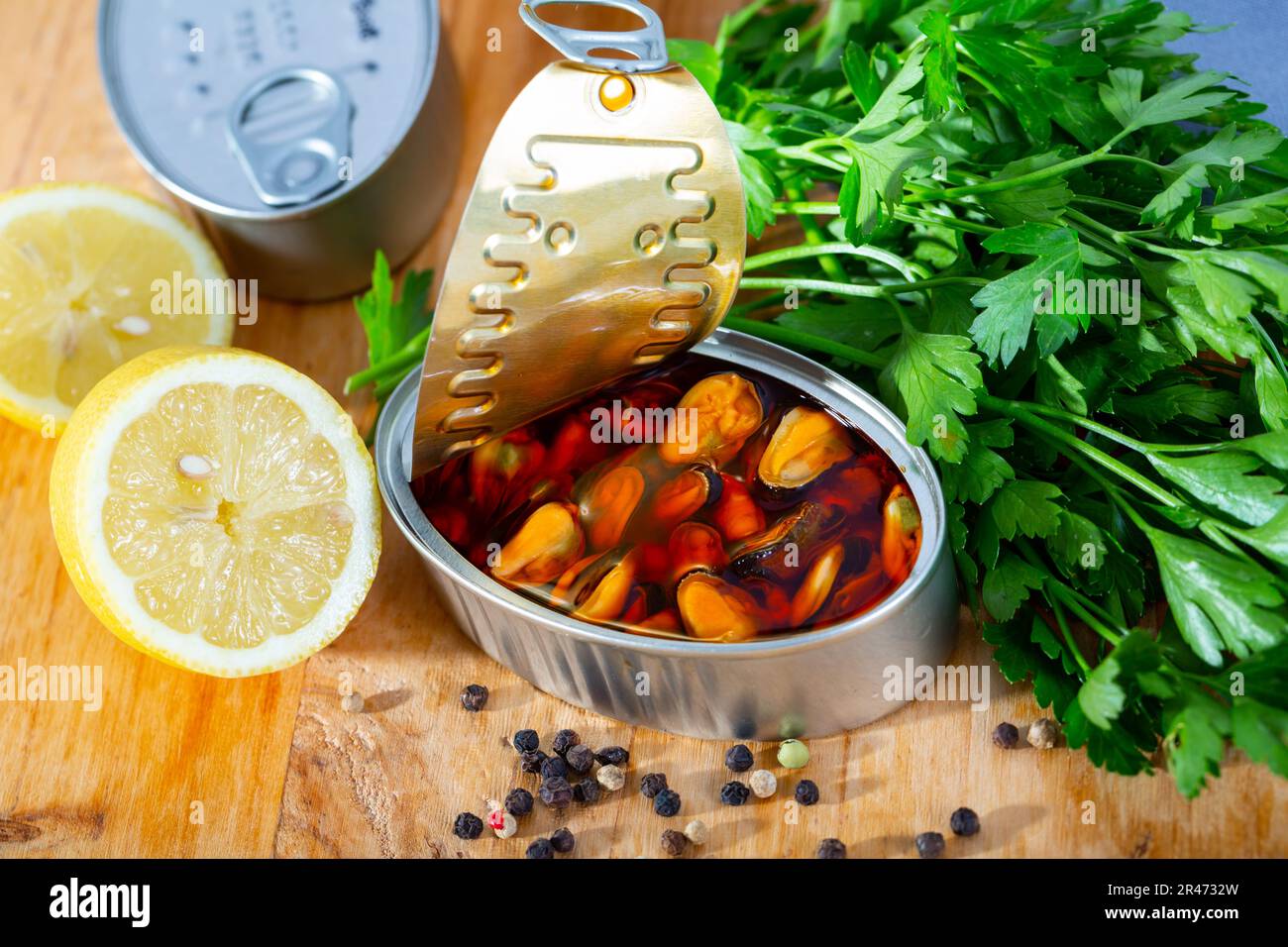 Marinated mussels in oil with herbs and lemon Stock Photo - Alamy