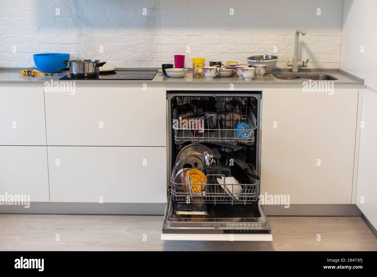 Build-in dishwasher with opened door in a white kitchen Stock Photo - Alamy