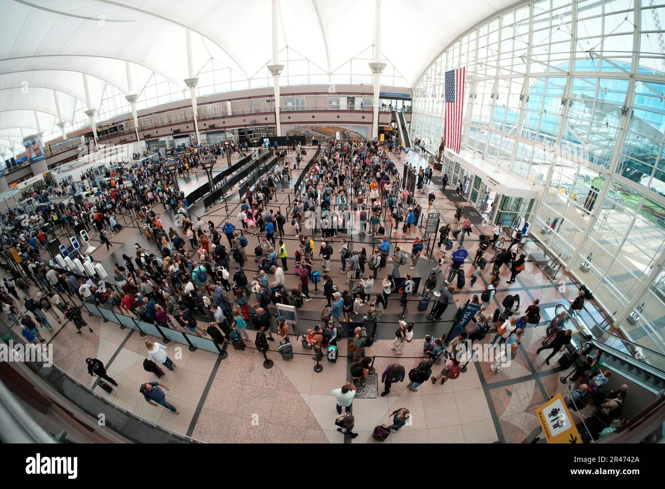 Travelers move through the south security checkpoint in Denver ...