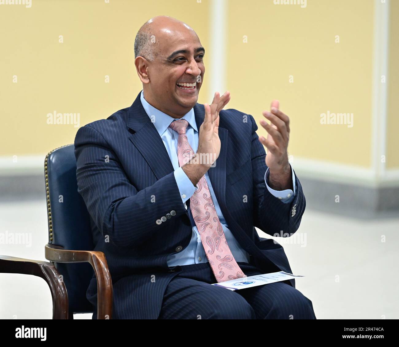 Dr. Ravi Chaudhary laughs during his swearing-in ceremony as the ...
