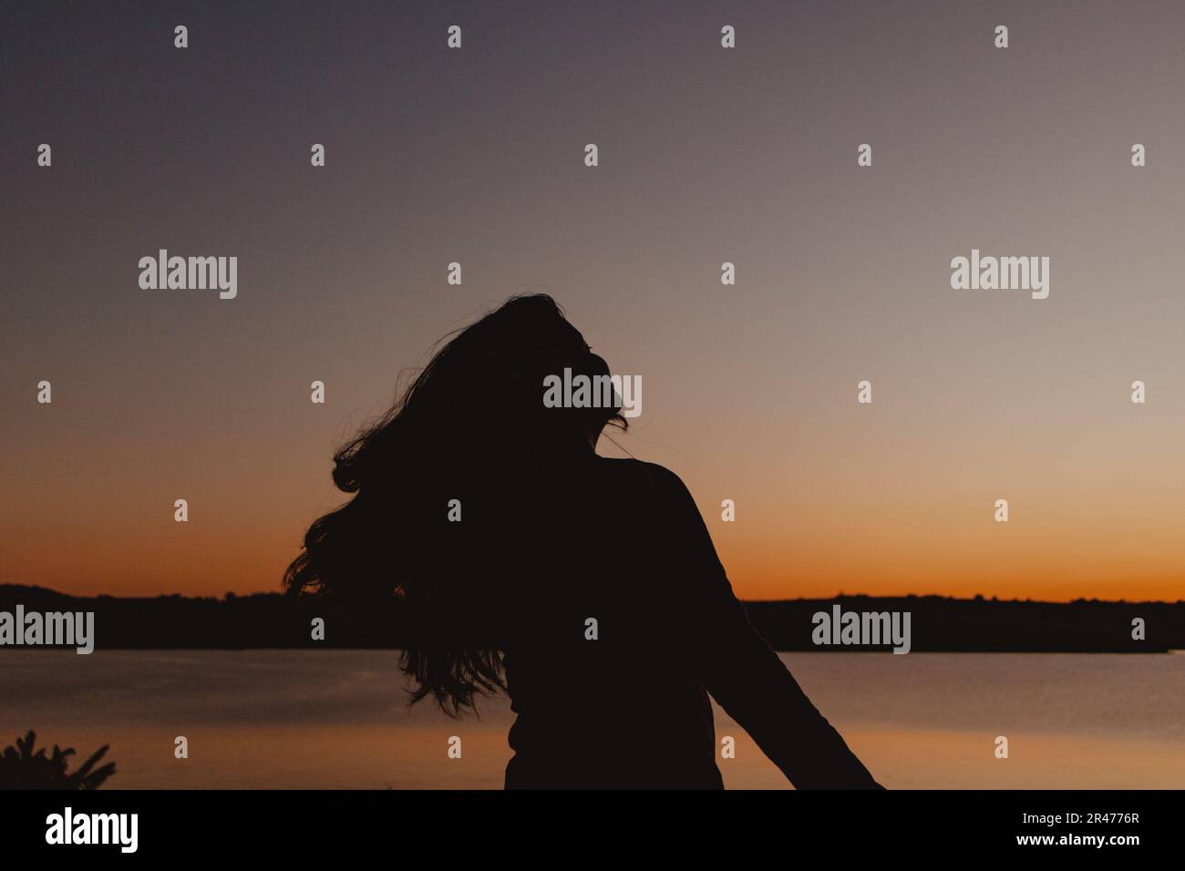 beautiful woman silhouette at dusk Stock Photo - Alamy