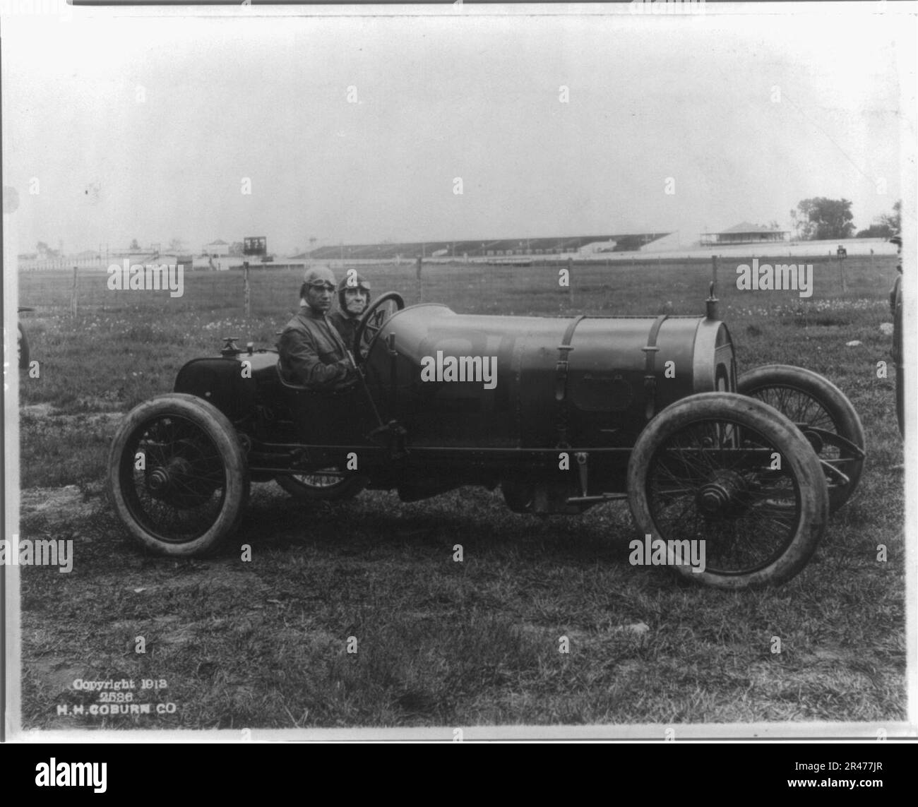 Unidentified men seated in racing cars Stock Photo - Alamy