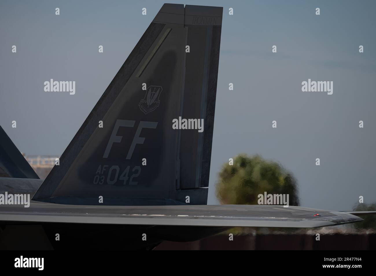A U.S. Air Force F-22 Raptor displays the 1st Fighter Wing tail flash ...
