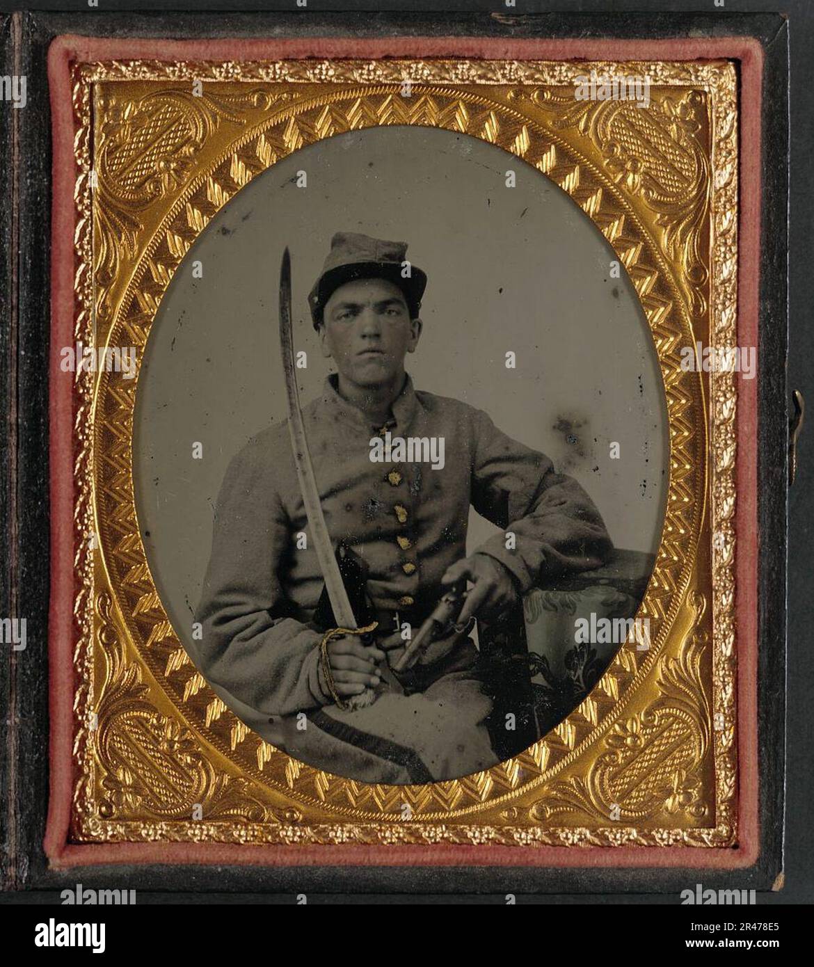 Unidentified soldier in Confederate uniform holding saber and revolver ...