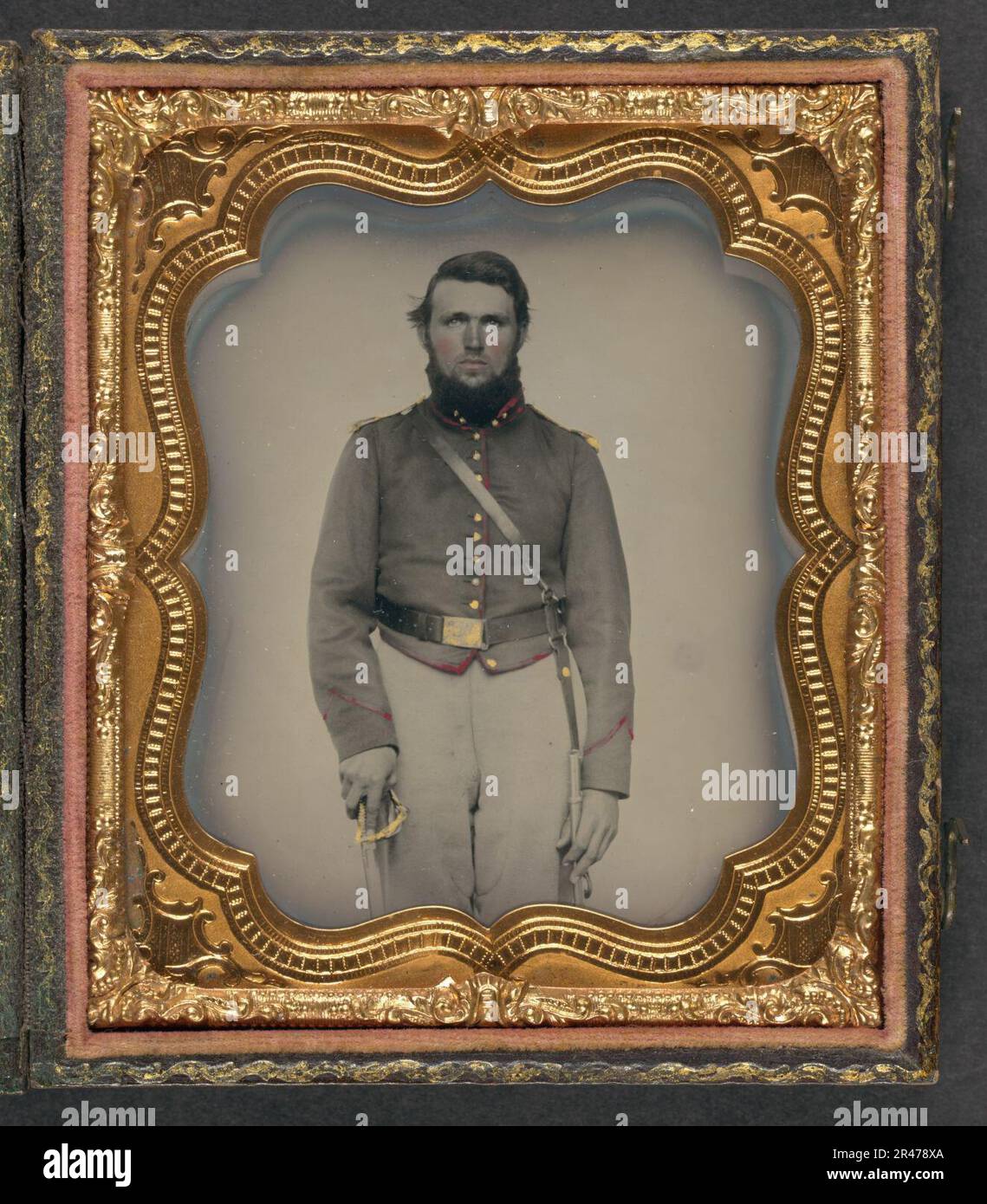 Unidentified soldier in Union artillery uniform with red piping holding ...