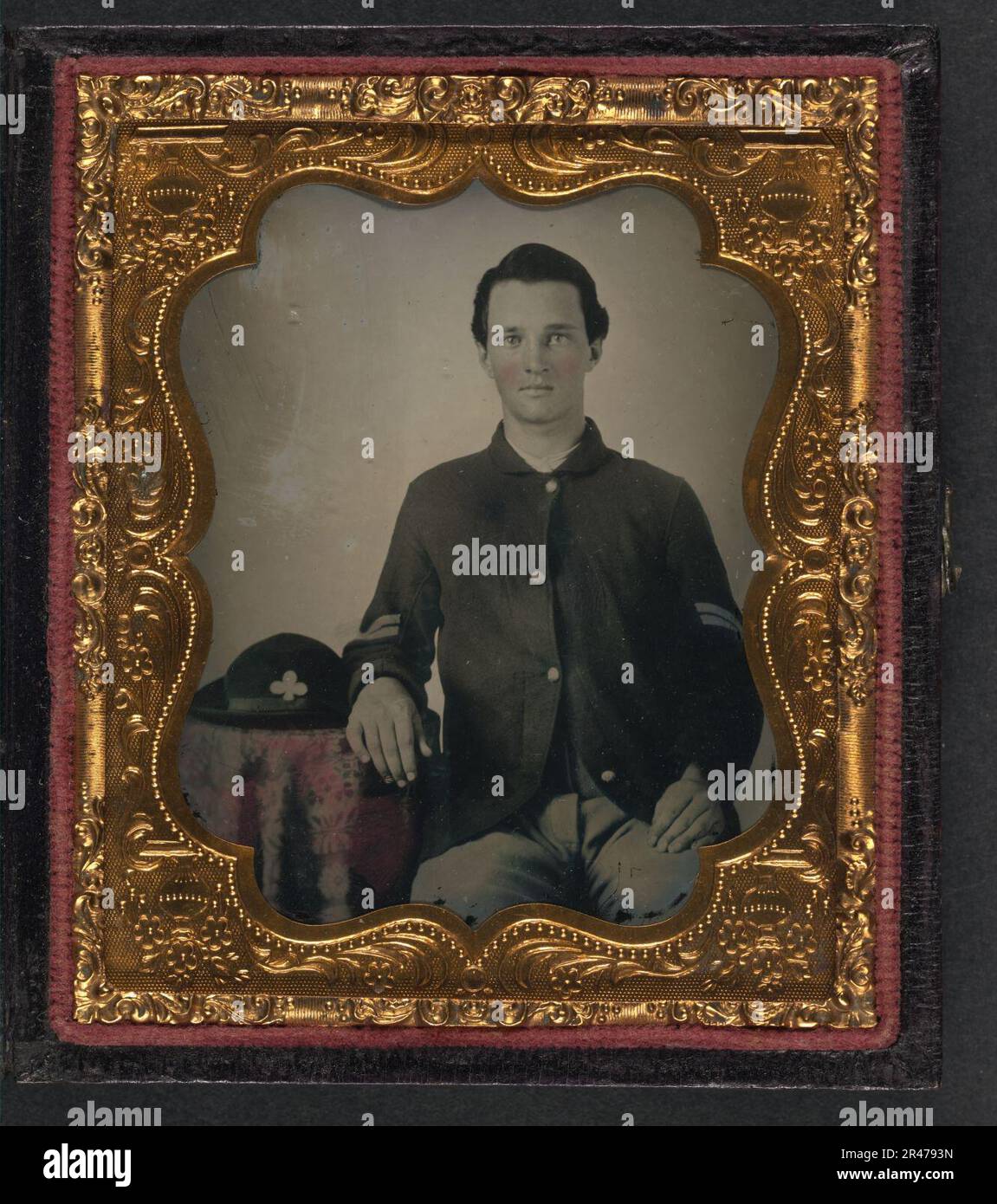 Unidentified soldier in Union corporal's uniform resting arm on table ...