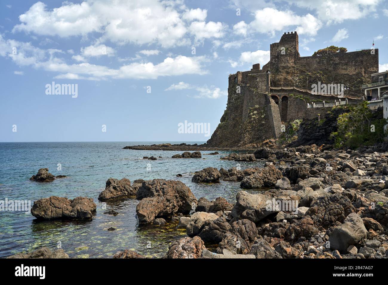 Ruins of a Norman castle on a volcanic cliff in the village of Aci ...