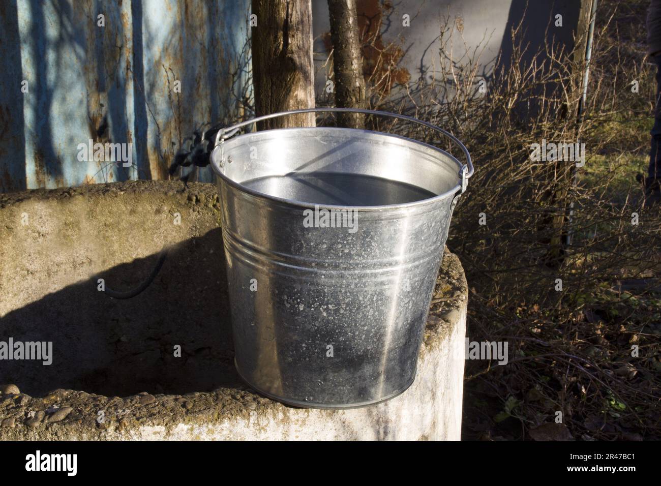 Rural landscape. A rural well with a filled bucket of water Stock Photo ...