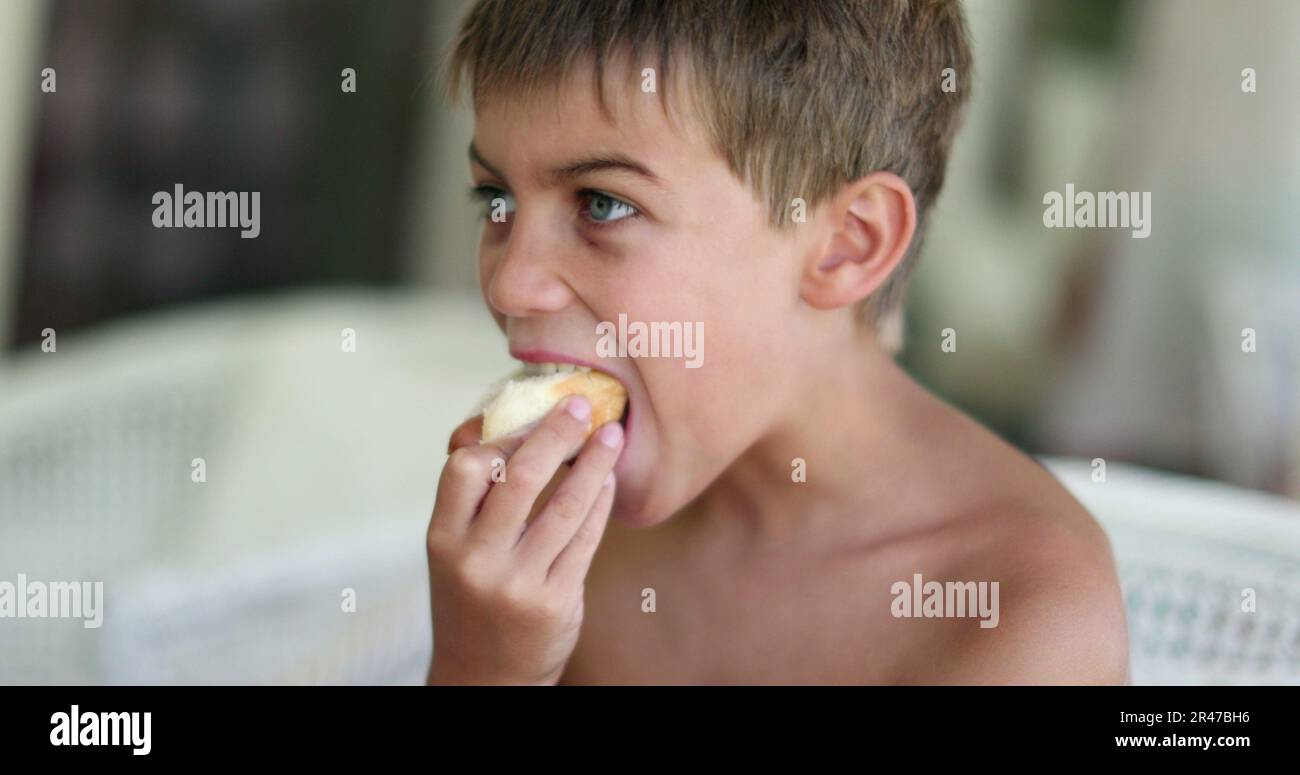Child taking a bite of hot-dog food Stock Photo - Alamy