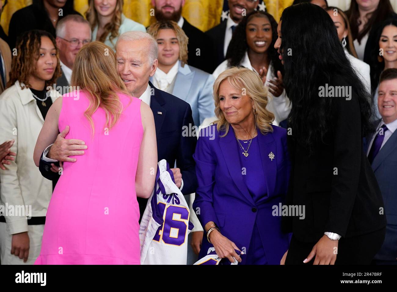 President Joe Biden hugs LSU's Emily Ward, left, as he stands with ...