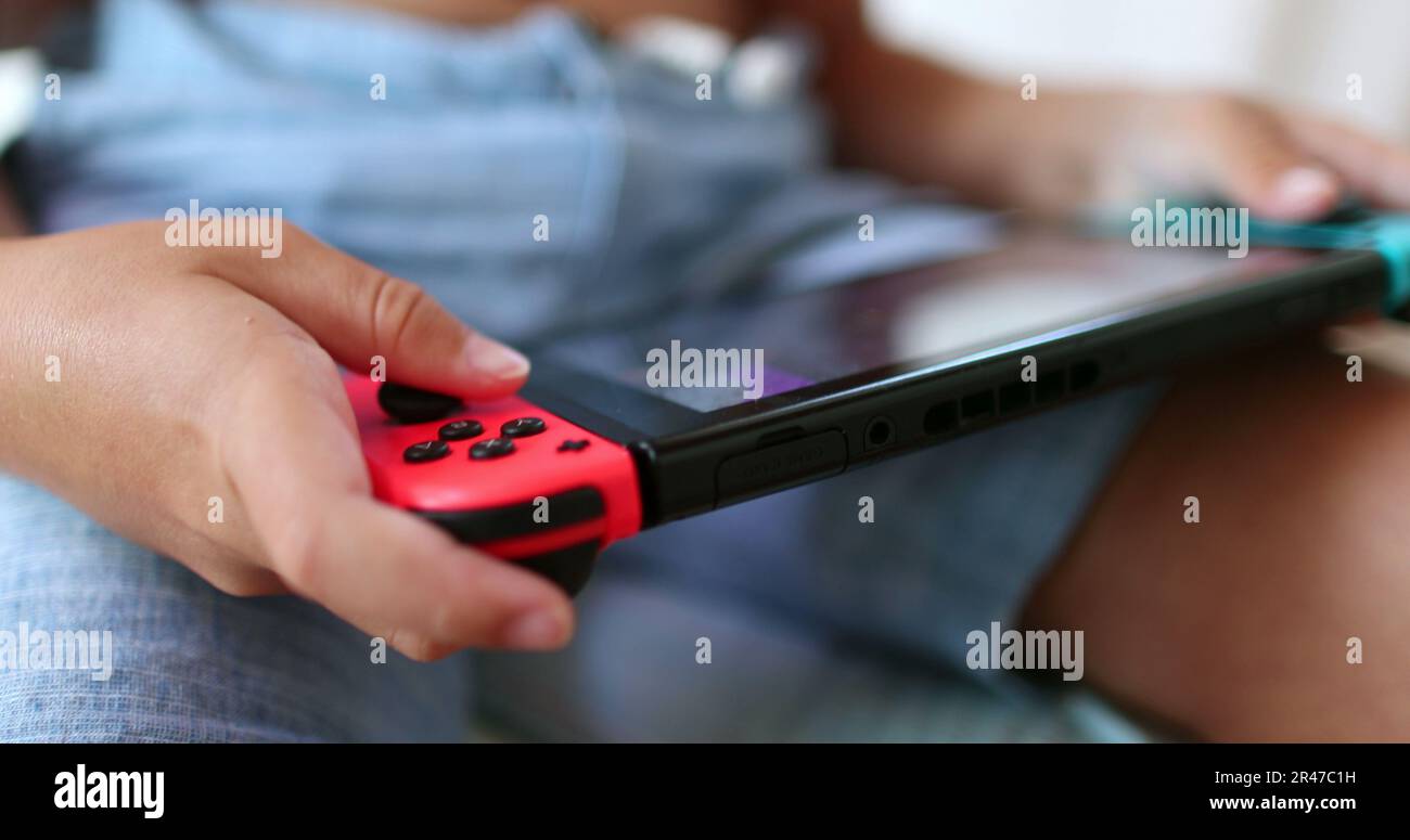 Close-up child hands holding video-game controller Stock Photo - Alamy