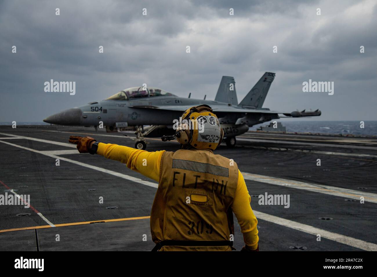 230408-N-BI507-1200 PHILIPPINE SEA (Apr 08, 2023) A Sailor directs an E/A-18G Growler from the ...