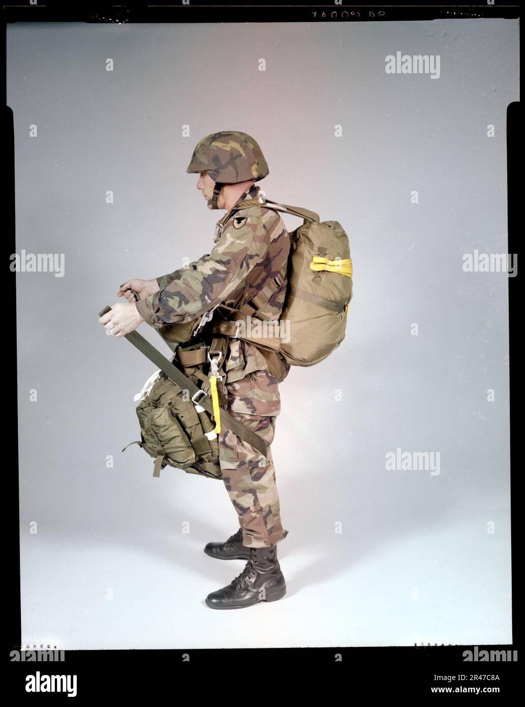 Uniformed soldier with parachuting supplies, side view, by U.S. Army ...