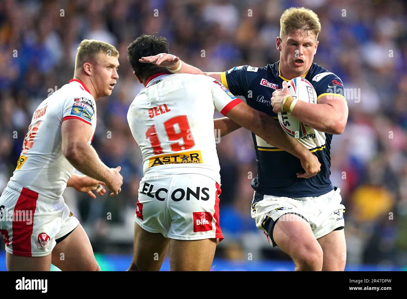 Leeds Rhinos' Tom Holroyd (right) is tackled by St Helens' James Bell ...