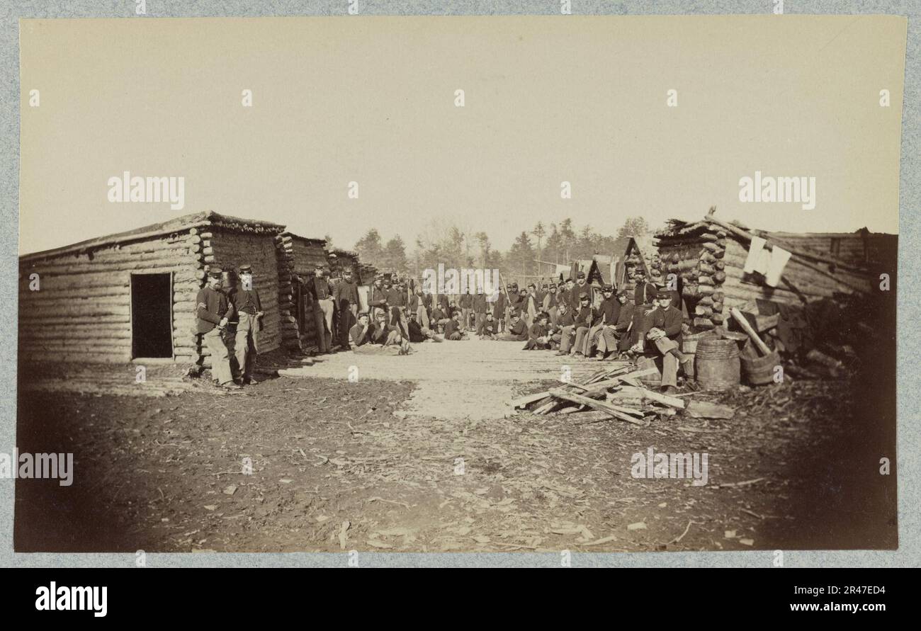 Union soldiers, in camp, posed in front of log buildings Stock Photo ...