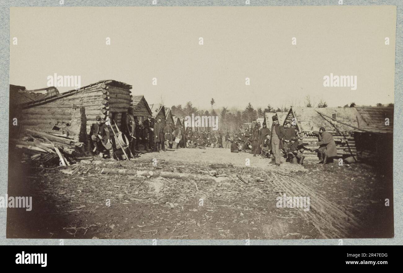 Union soldiers, in camp, posed in front of log buildings Stock Photo ...