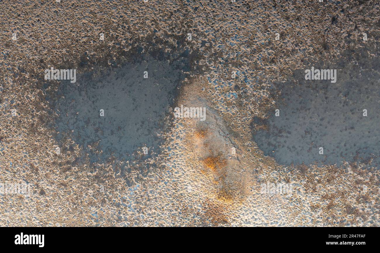 An aerial view of a drying sea bed with remainig pools and numerous ...
