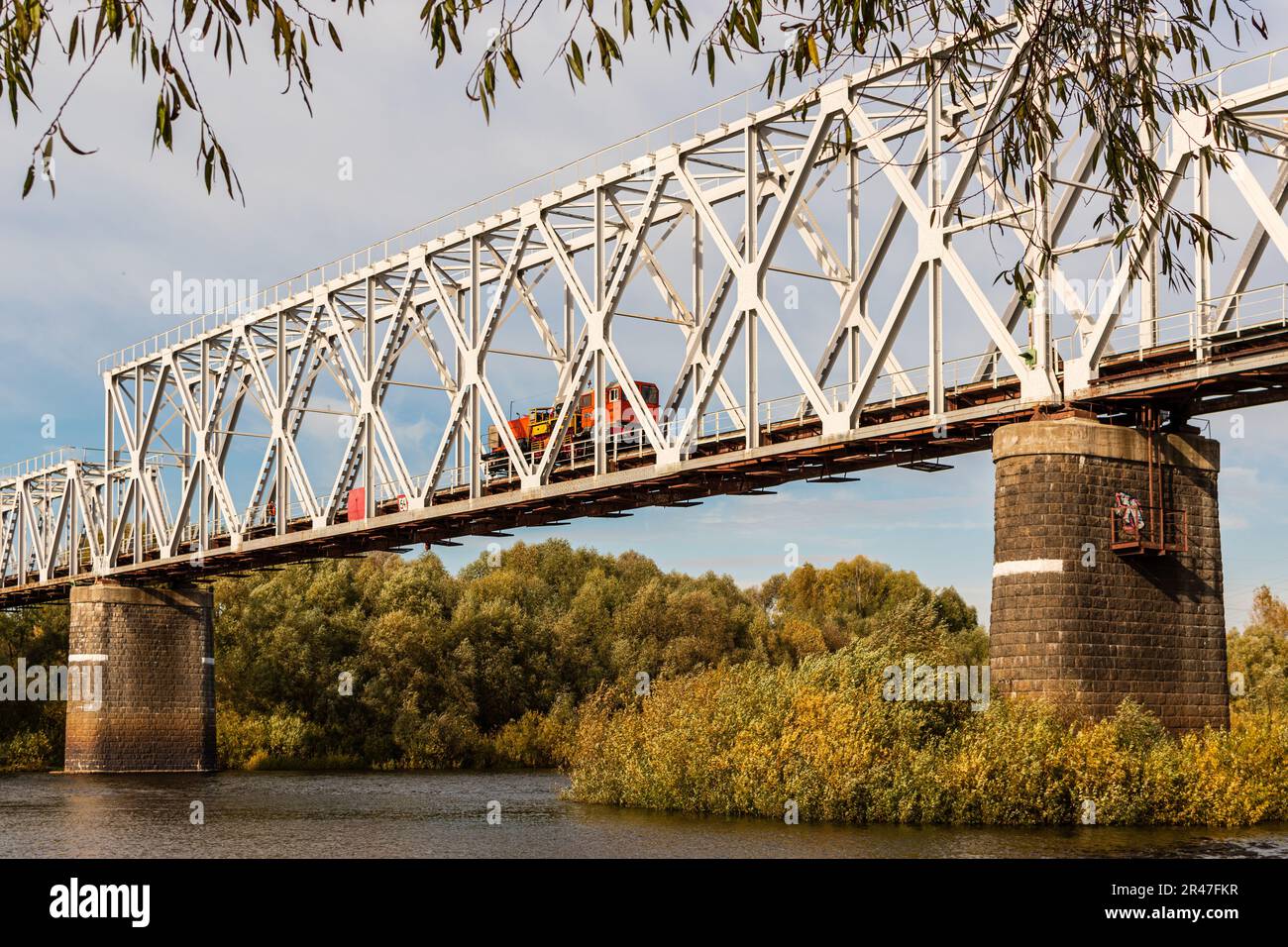 A picturesque view of a train traveling along a railway bridge over a ...