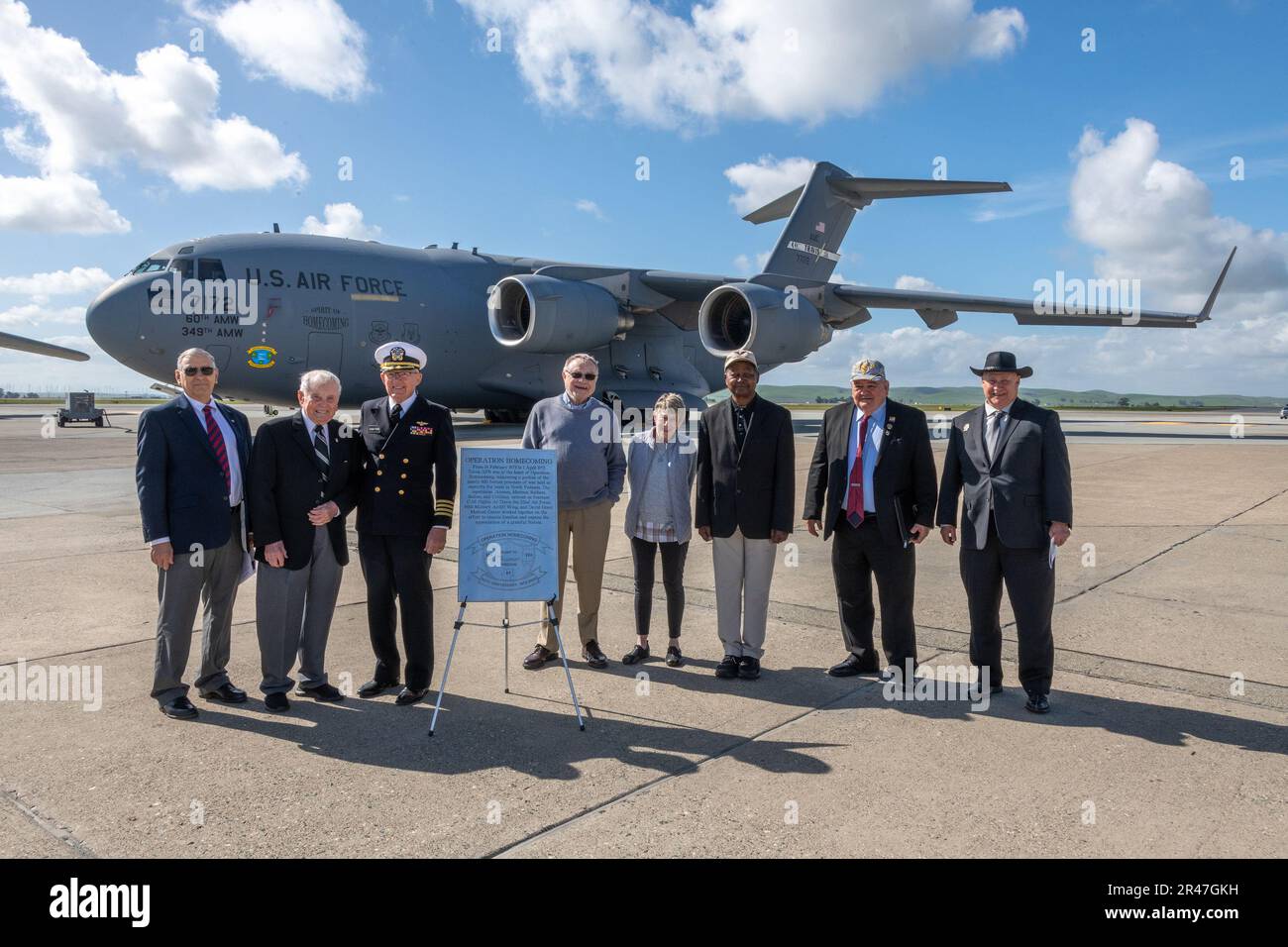 U.S. military veterans and family members stand by a commemorative ...