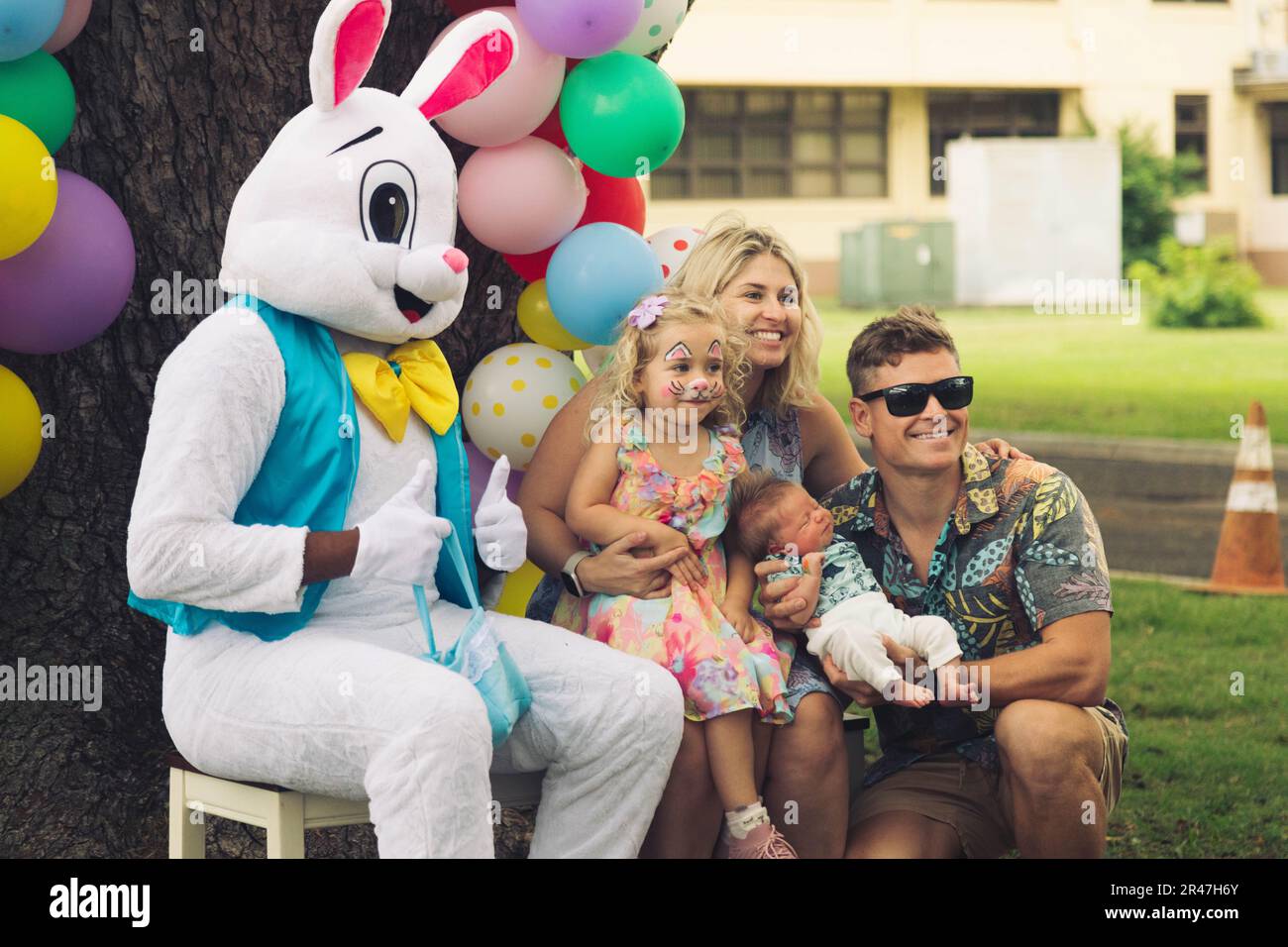 A family poses with a mascot for a photo during the Headquarters ...