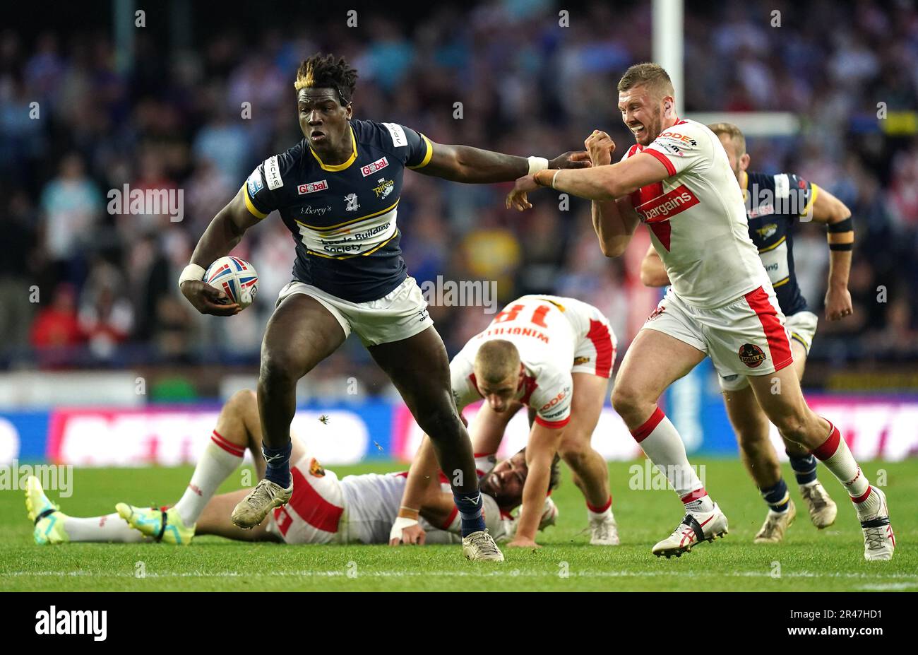 Leeds Rhinos' Justin Sangare breaks free from St Helens' Joe Batchelor ...