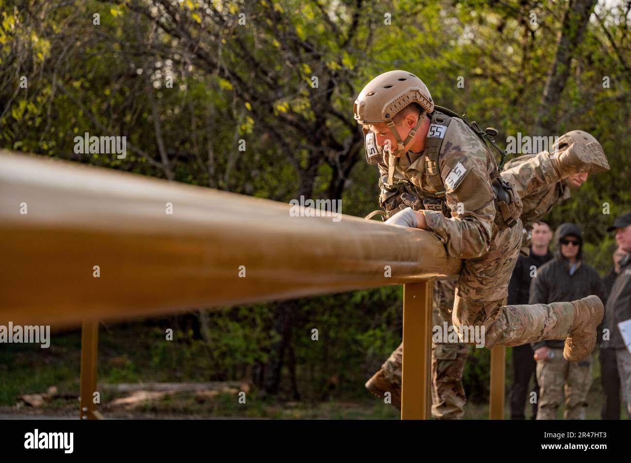 As teams, candidates maneuver an obstacle course during the Special ...