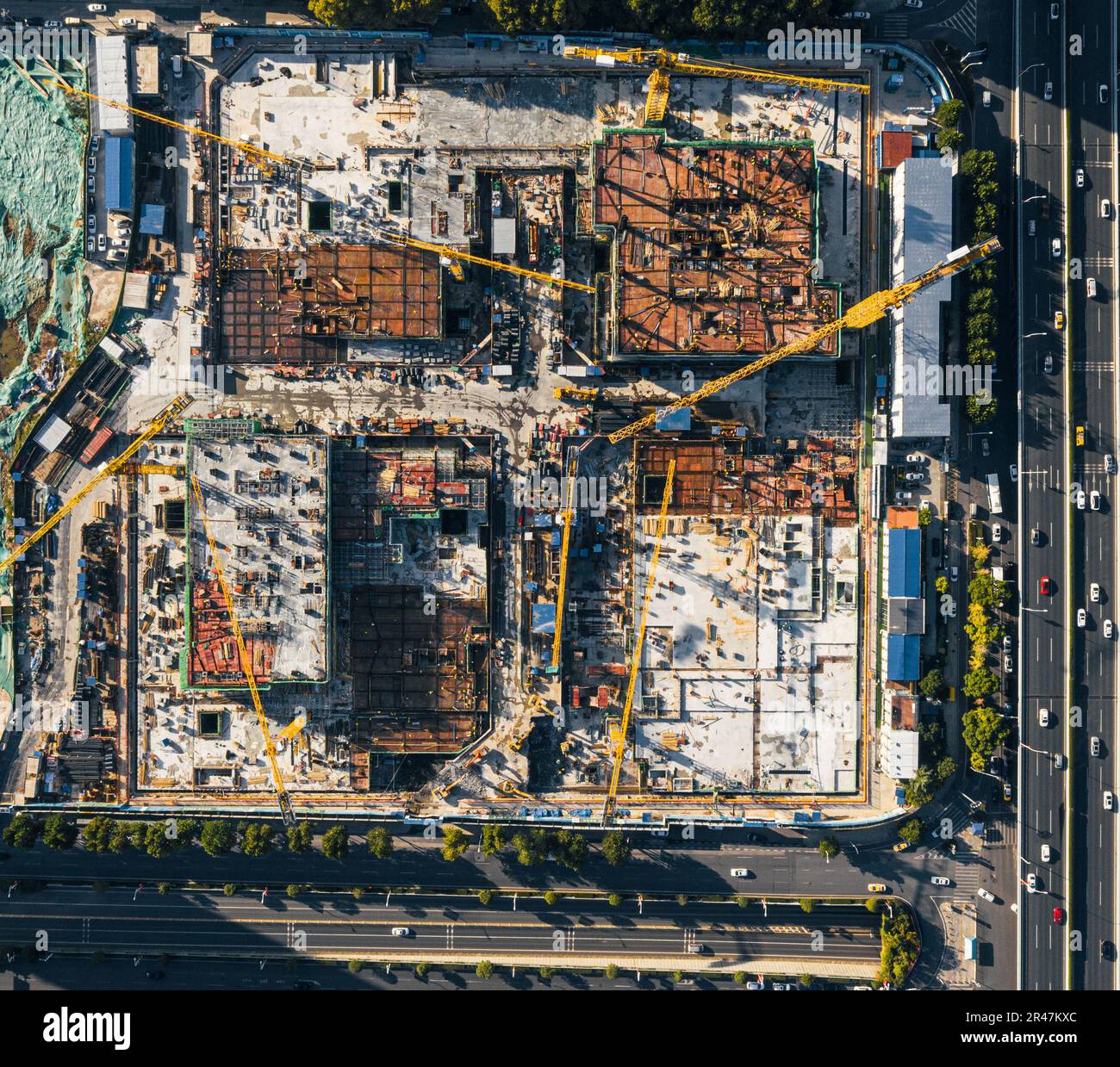 An aerial view of a construction site, showing a variety of workers ...
