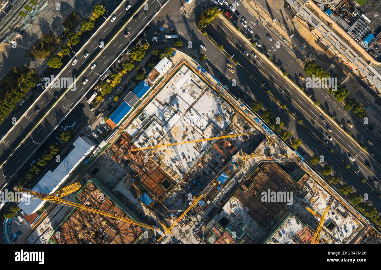 Aerial view of a construction site on a sunny day, featuring a bustling ...