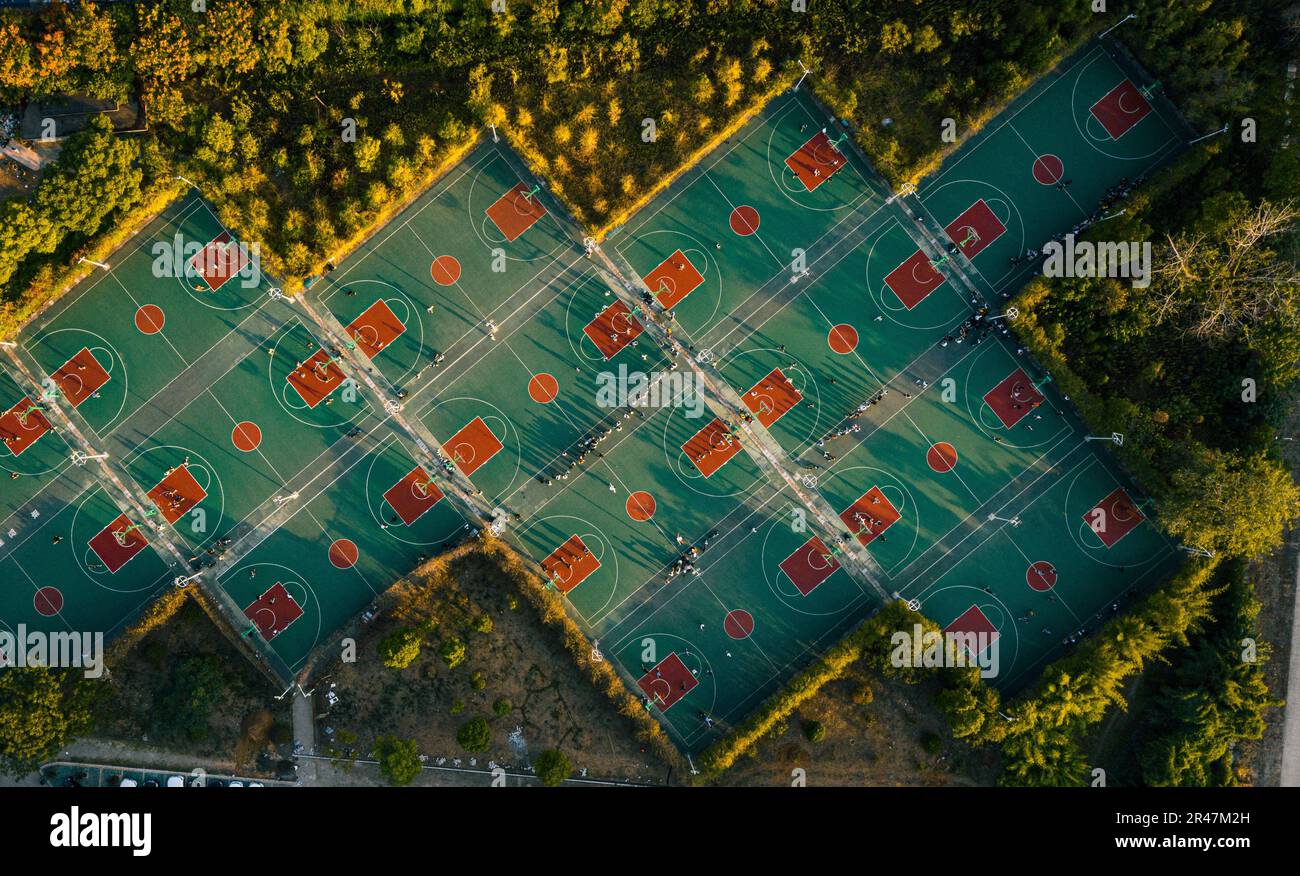 An aerial view of multiple tennis courts situated in the center of a ...